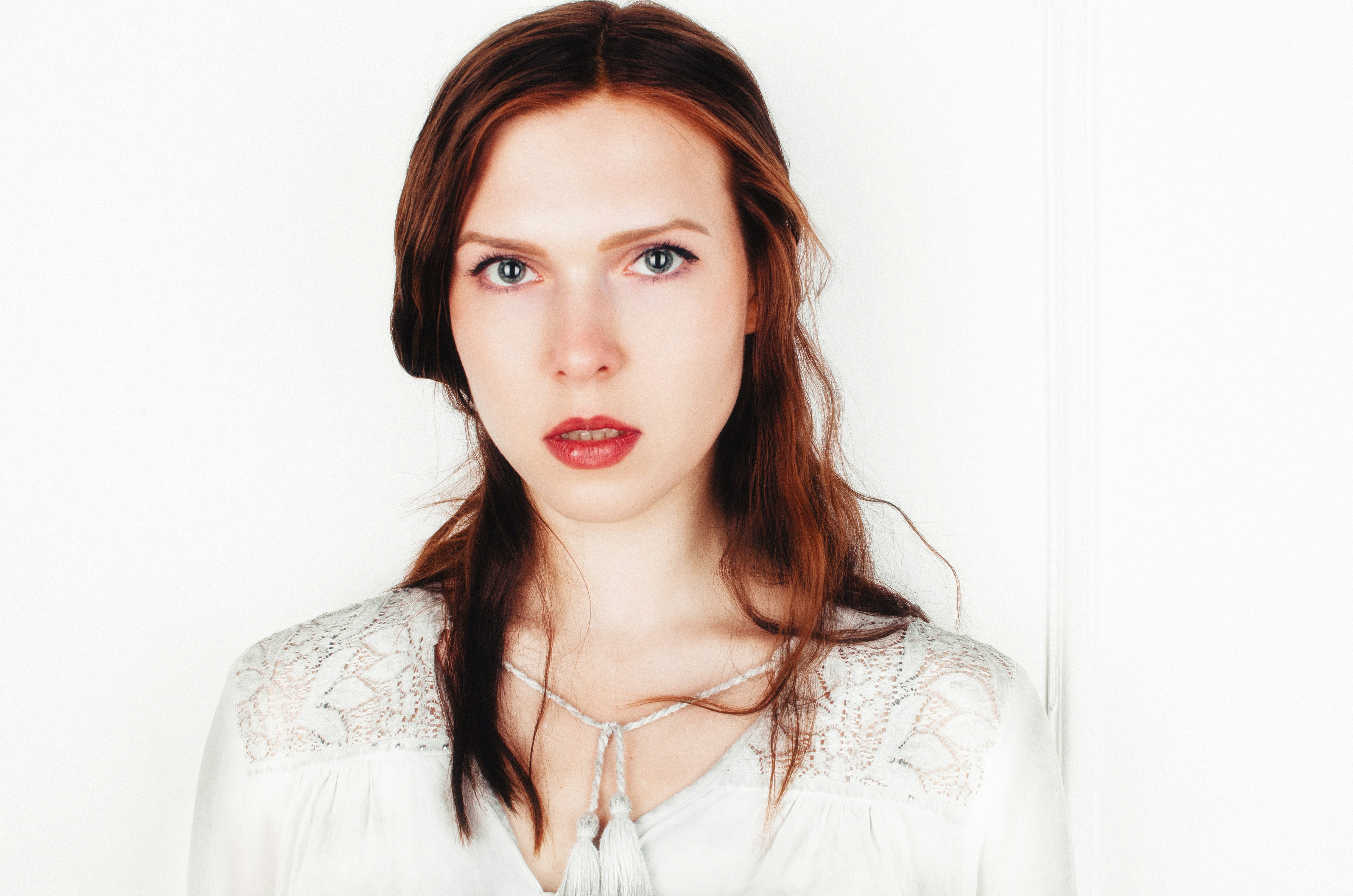 Young woman with reddish-brown hair and red lipstick.