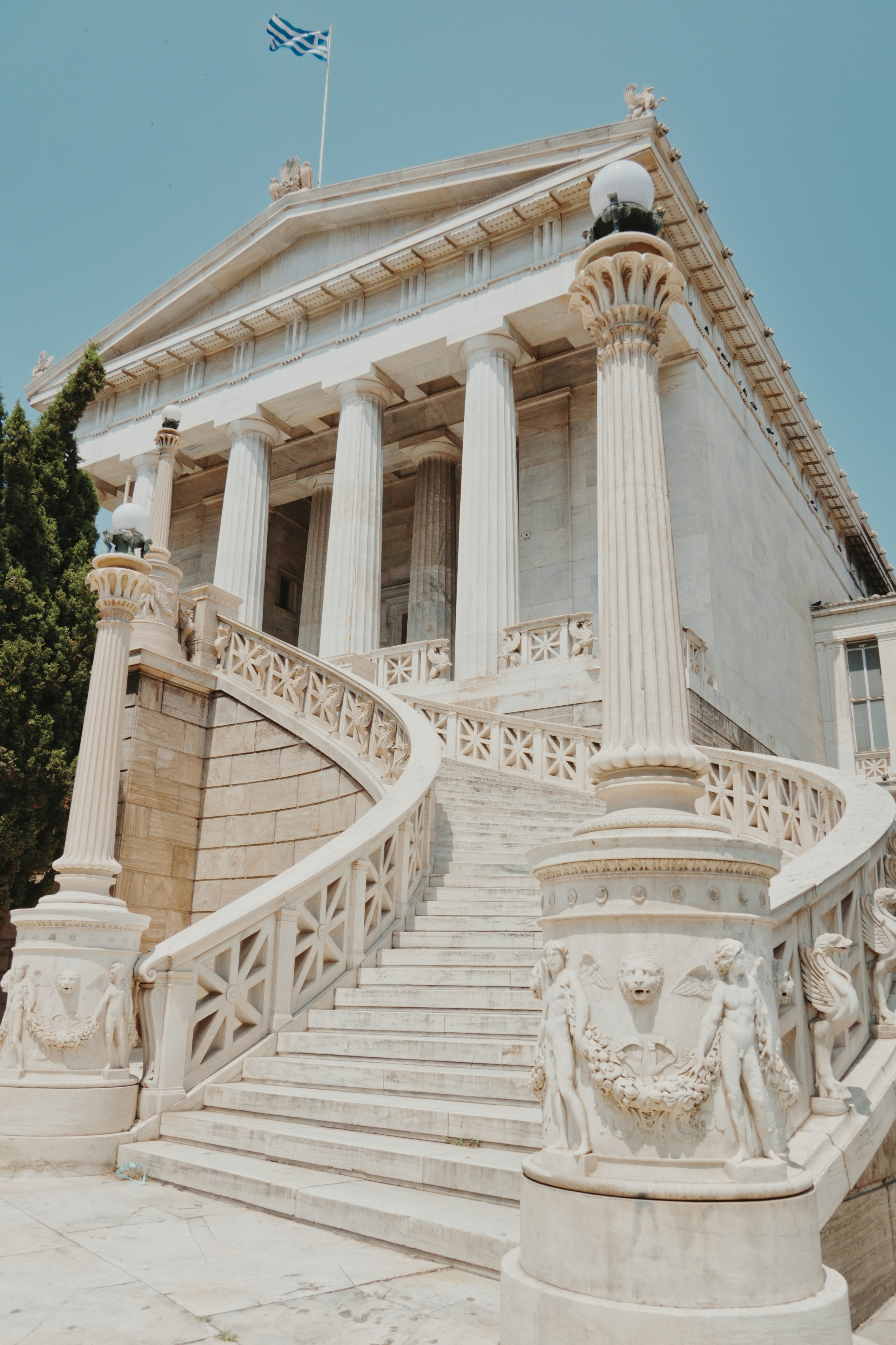 Grand marble staircase leading to a neoclassical building