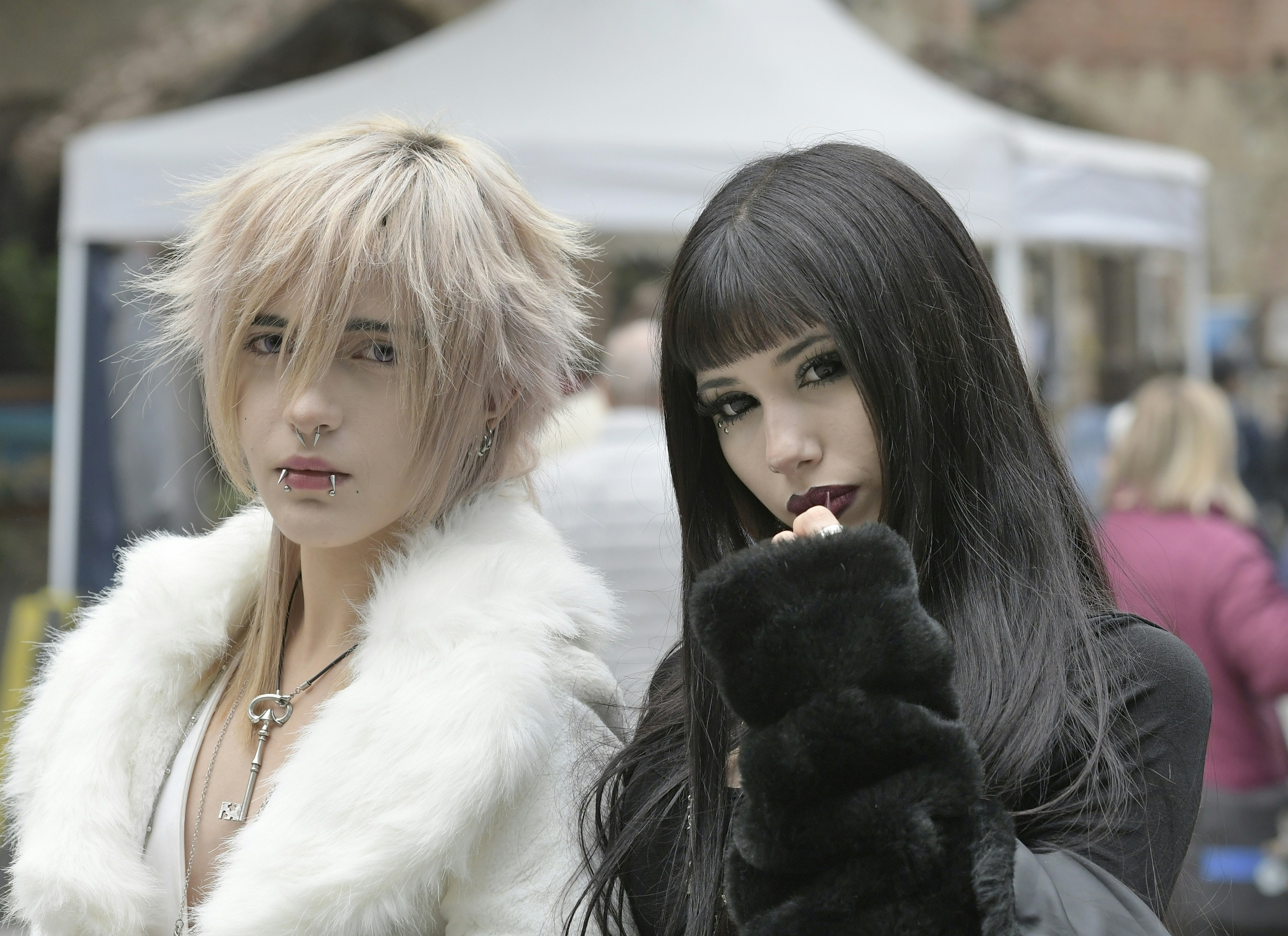 Two young women with distinctive hairstyles and alternative styles.