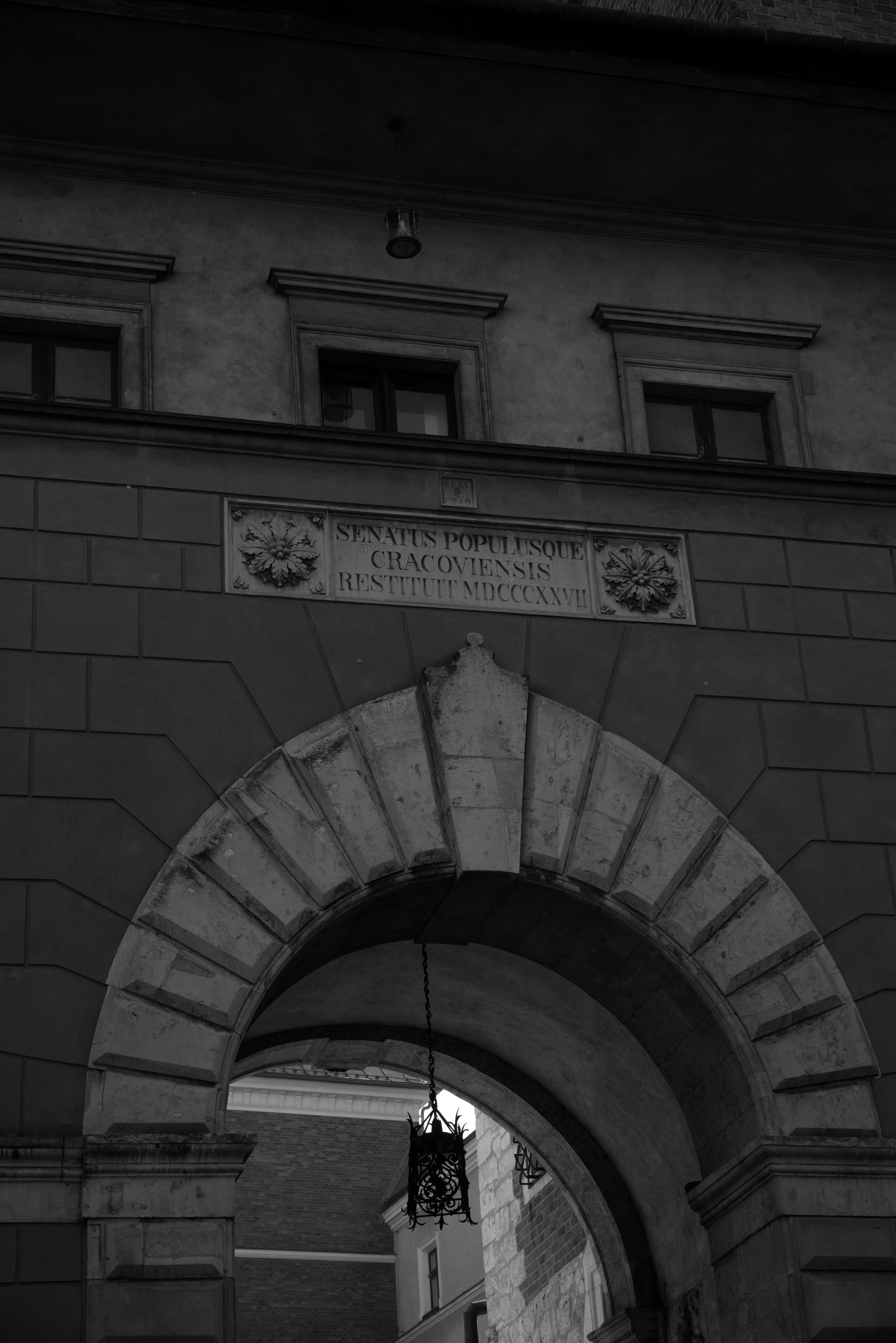 Stone archway with inscription and windows above