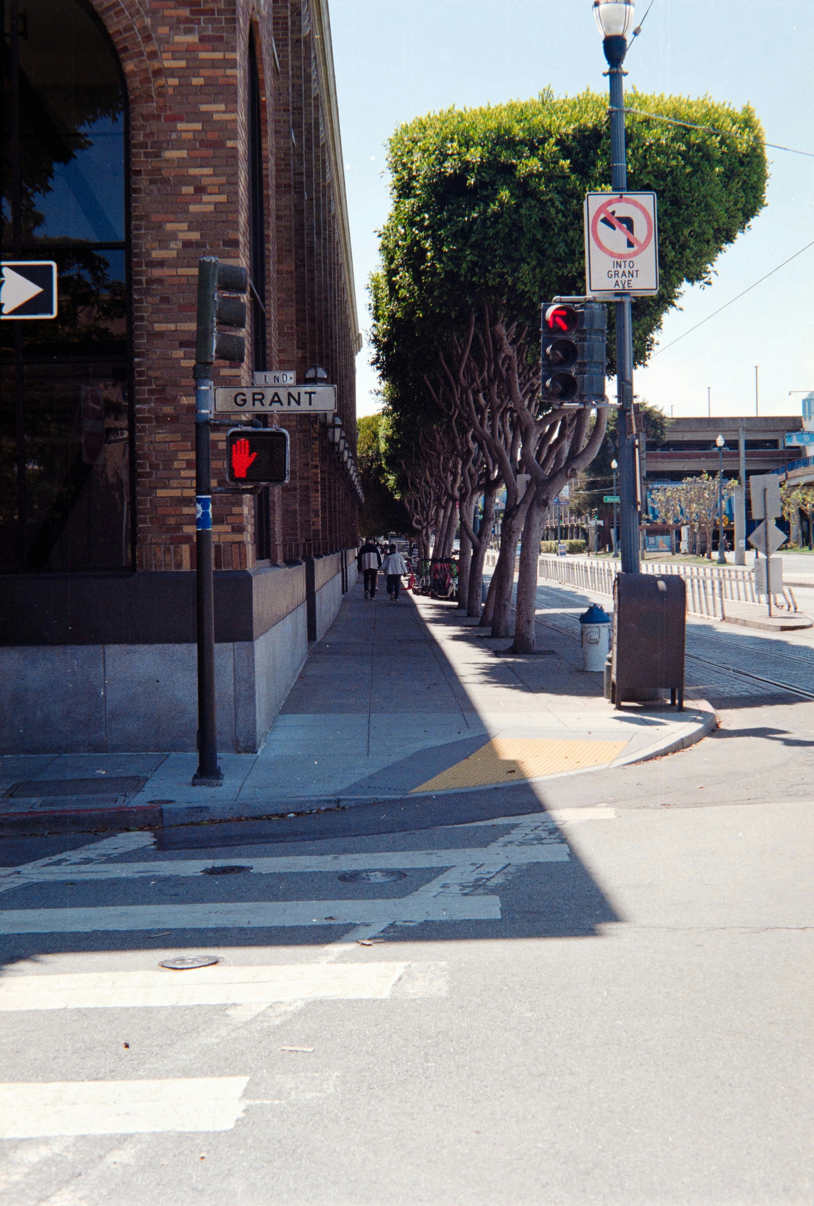 Red Hand Signal at Grant Street Crossing, Sunlit Urban Corner