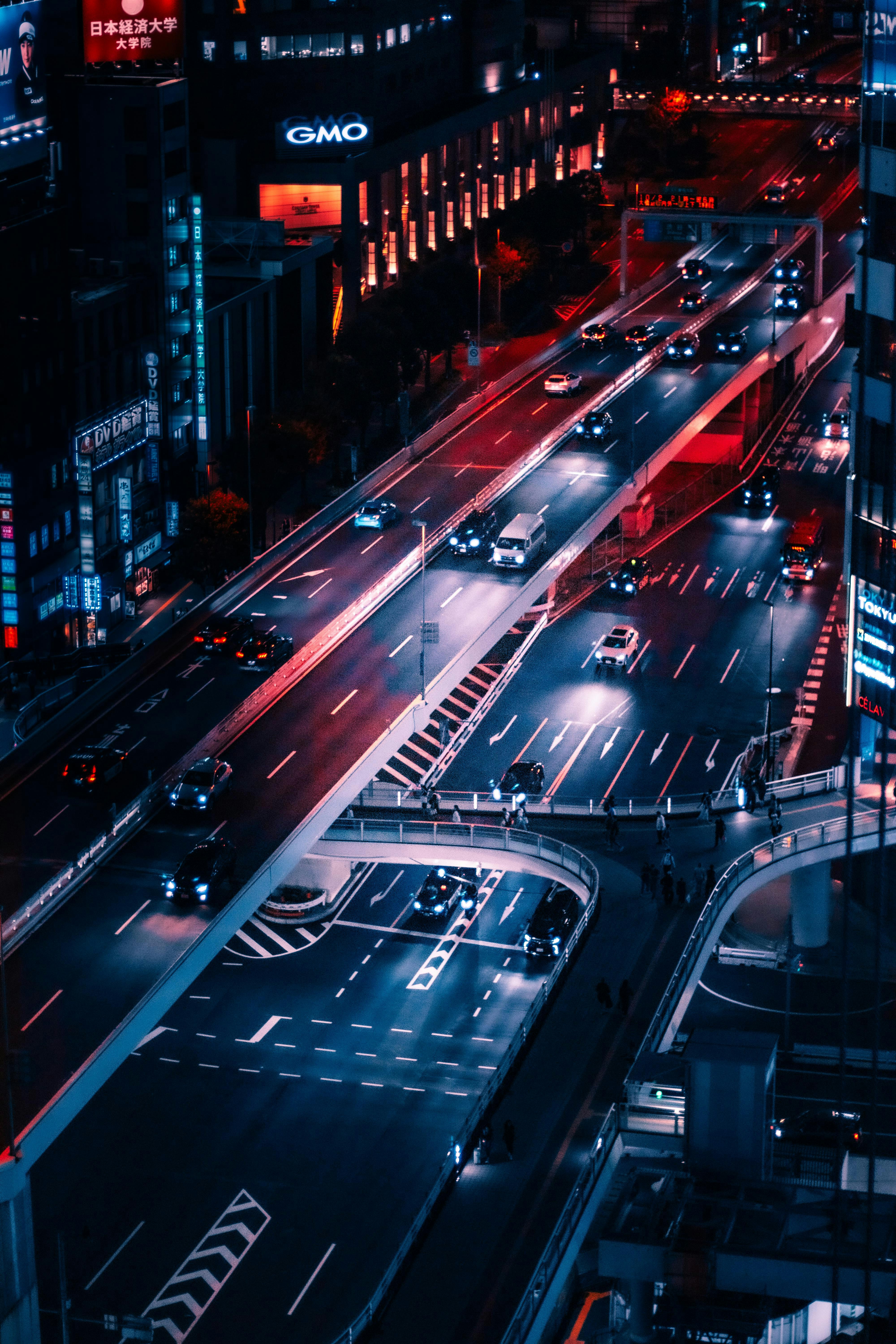 Cars driving on a highway at night.