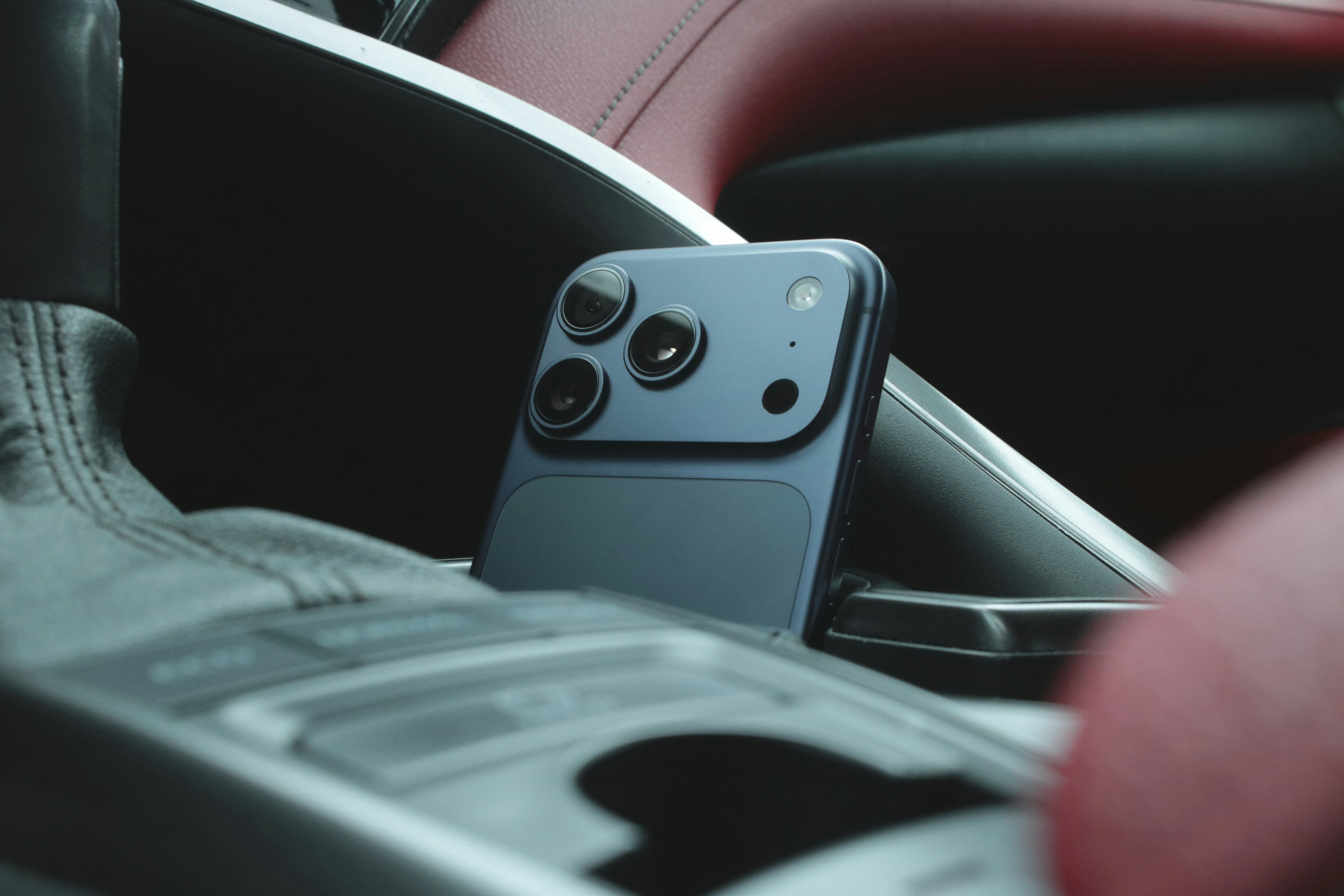 Smartphone resting in a car's center console.