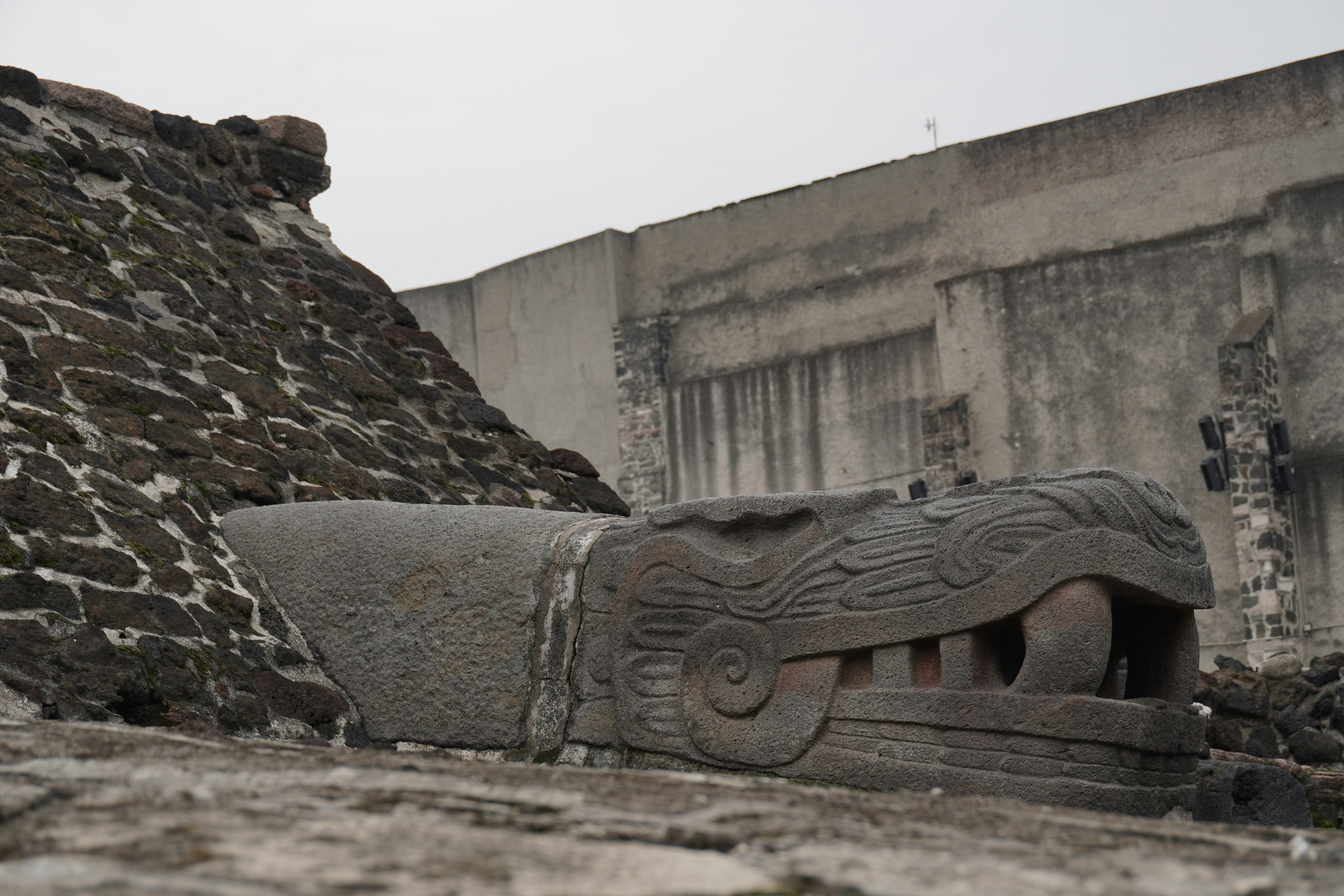 Stone serpent head sculpture at ancient ruins