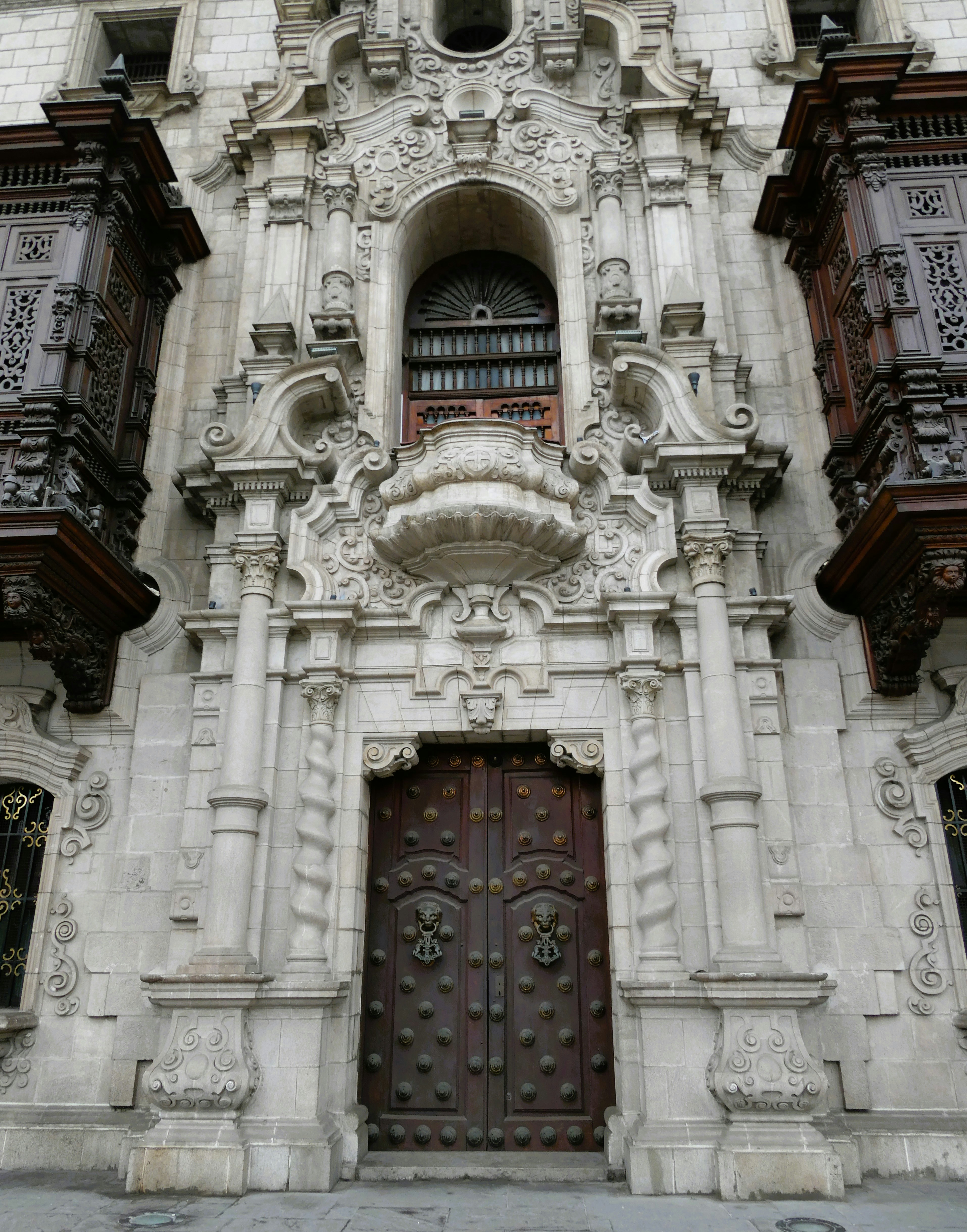 Archbishop’s Palace, Plaza Mayor, Lima, Peru | Ornate stone facade with wooden doors and balconies.