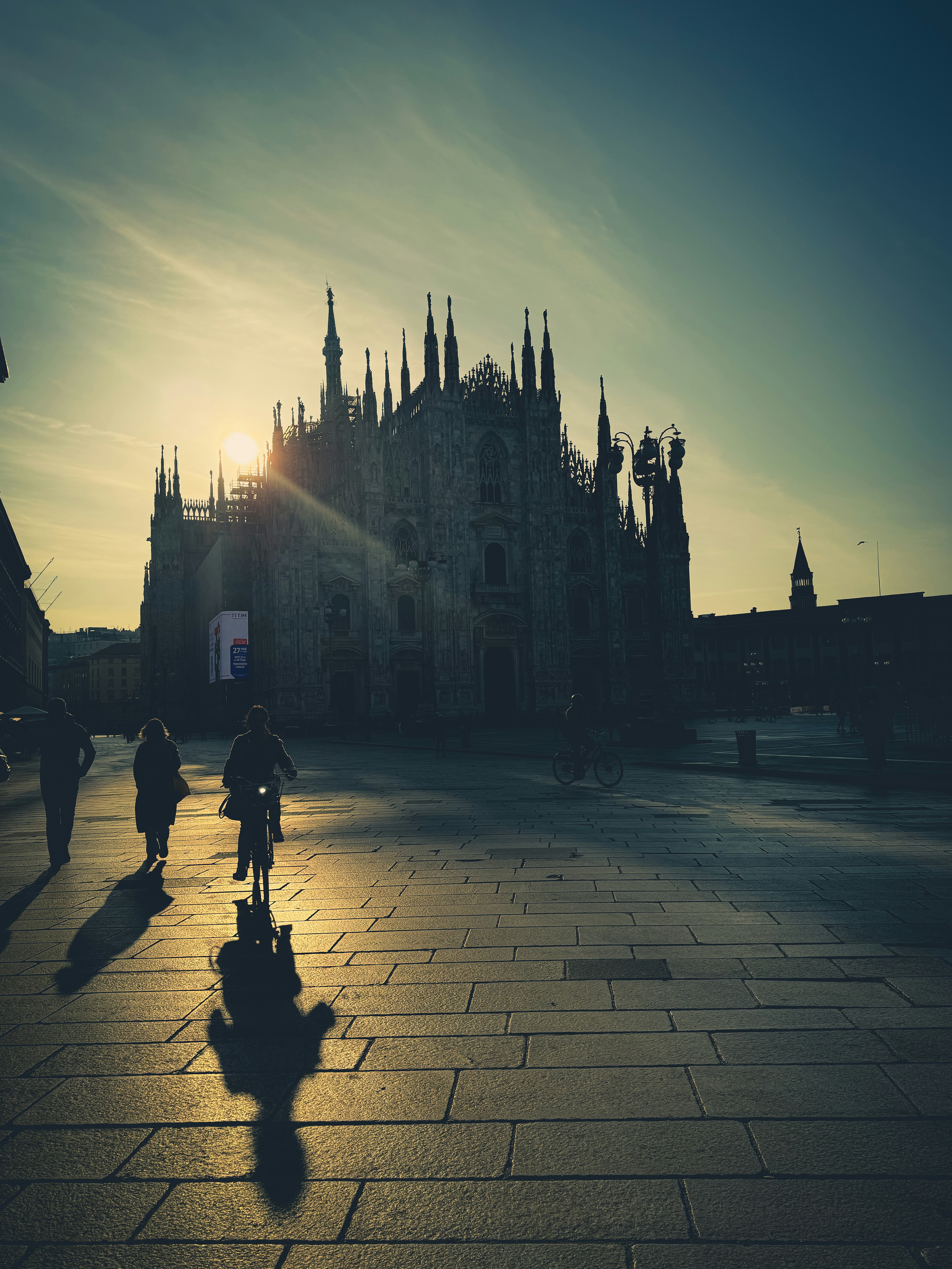 Duomo | Silhouettes walk past duomo di milano at sunset.