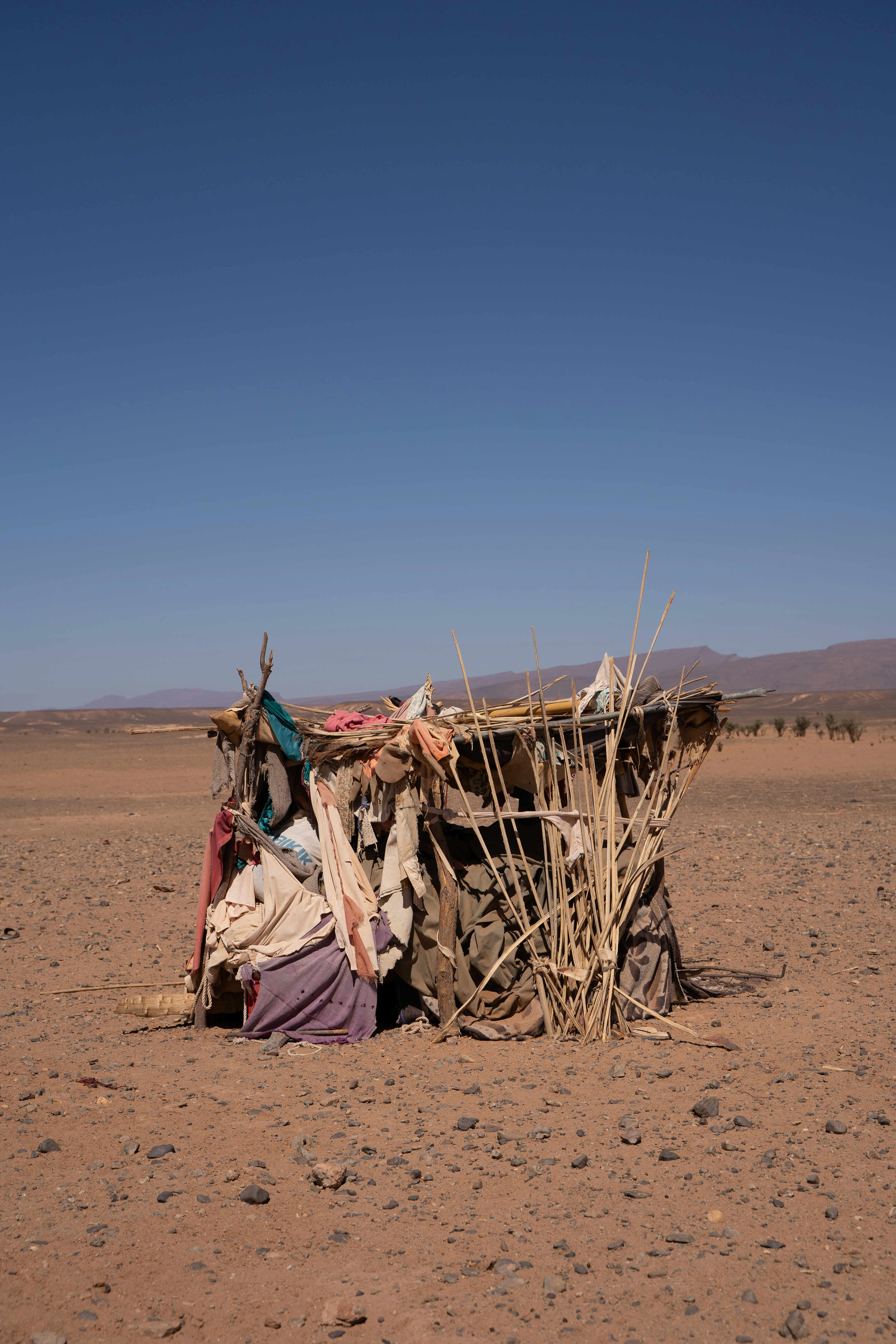 Makeshift shelter in a barren desert landscape