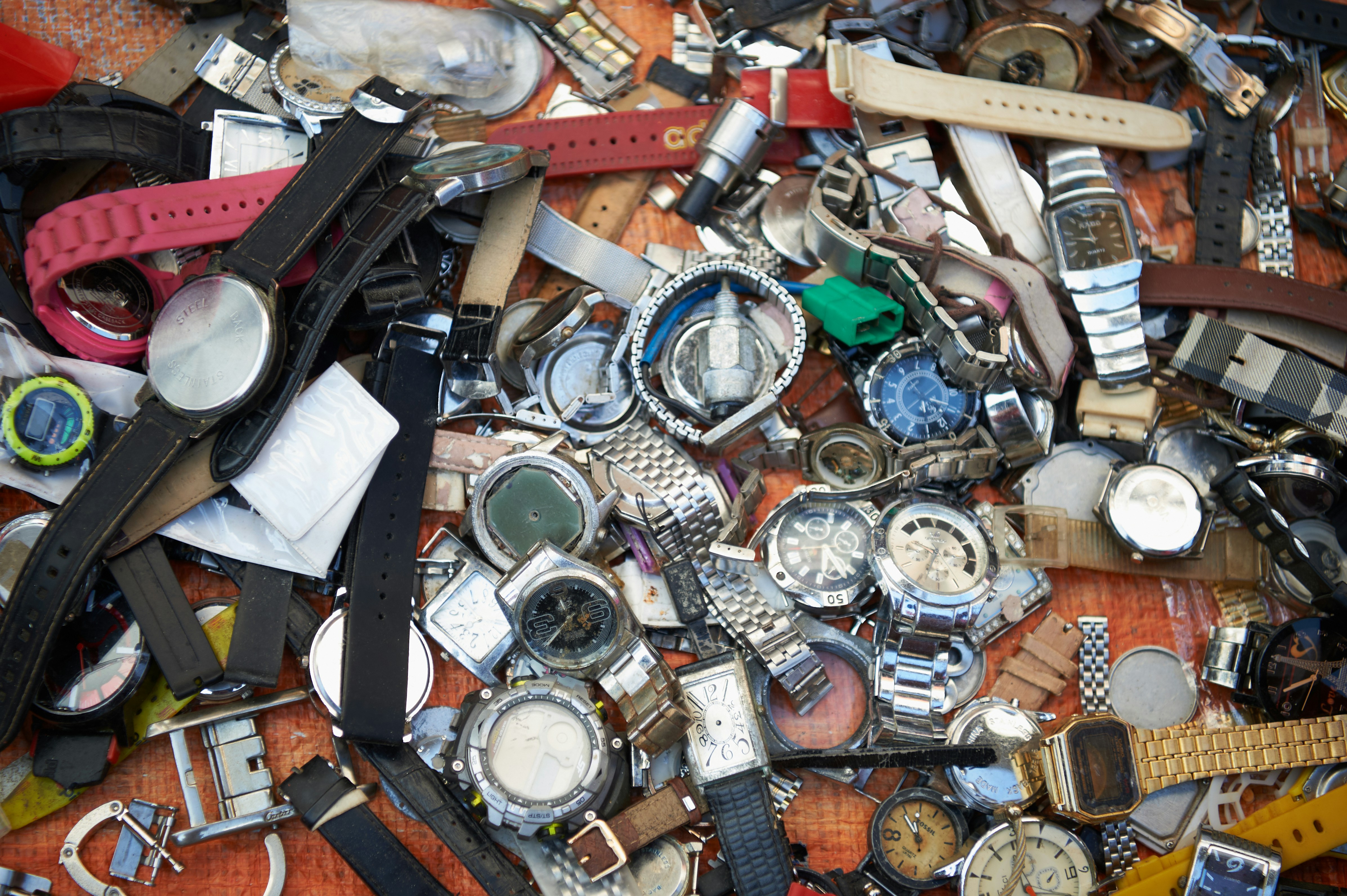 watches | A large pile of assorted wristwatches