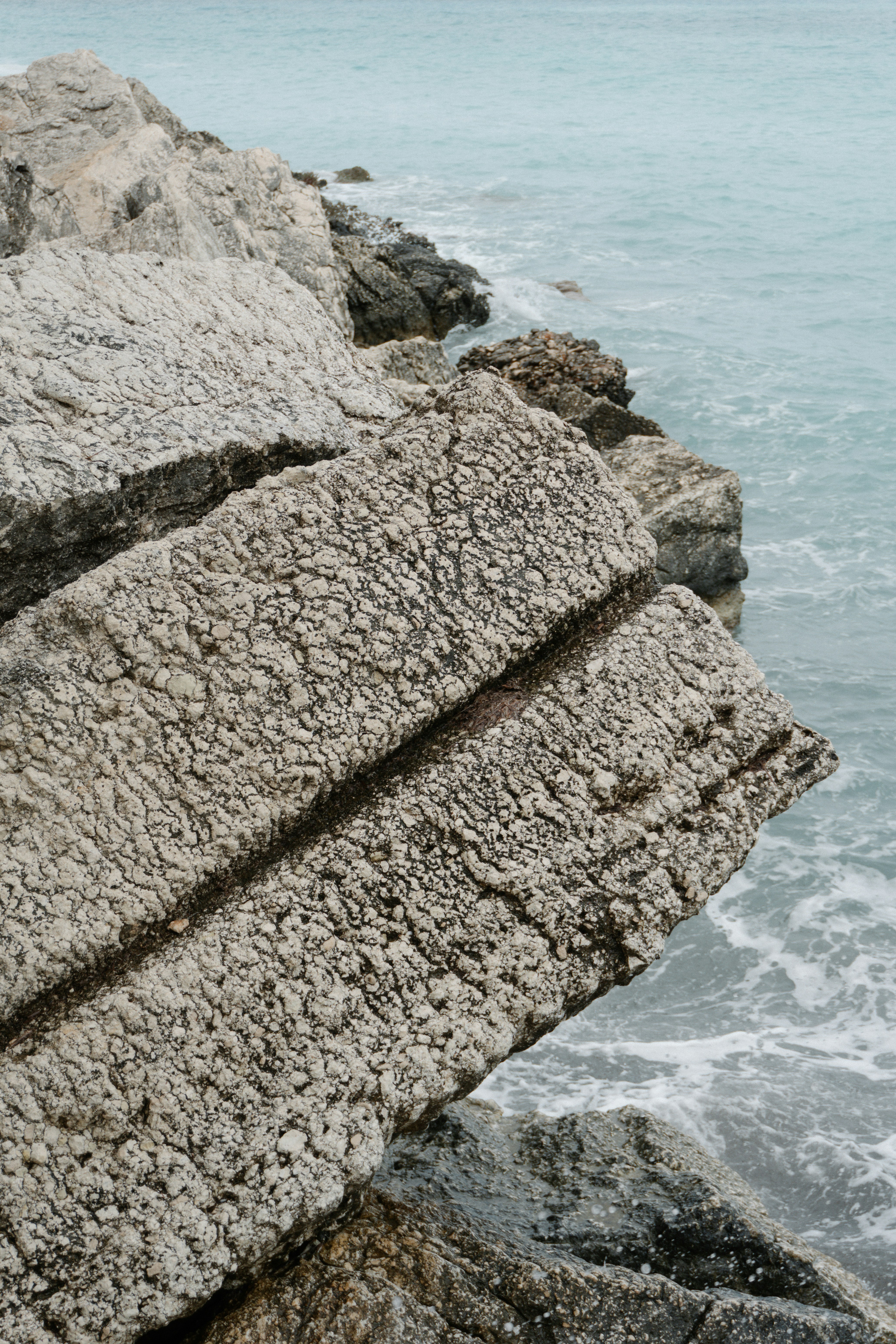 Rocky coastline with waves gently lapping shore.