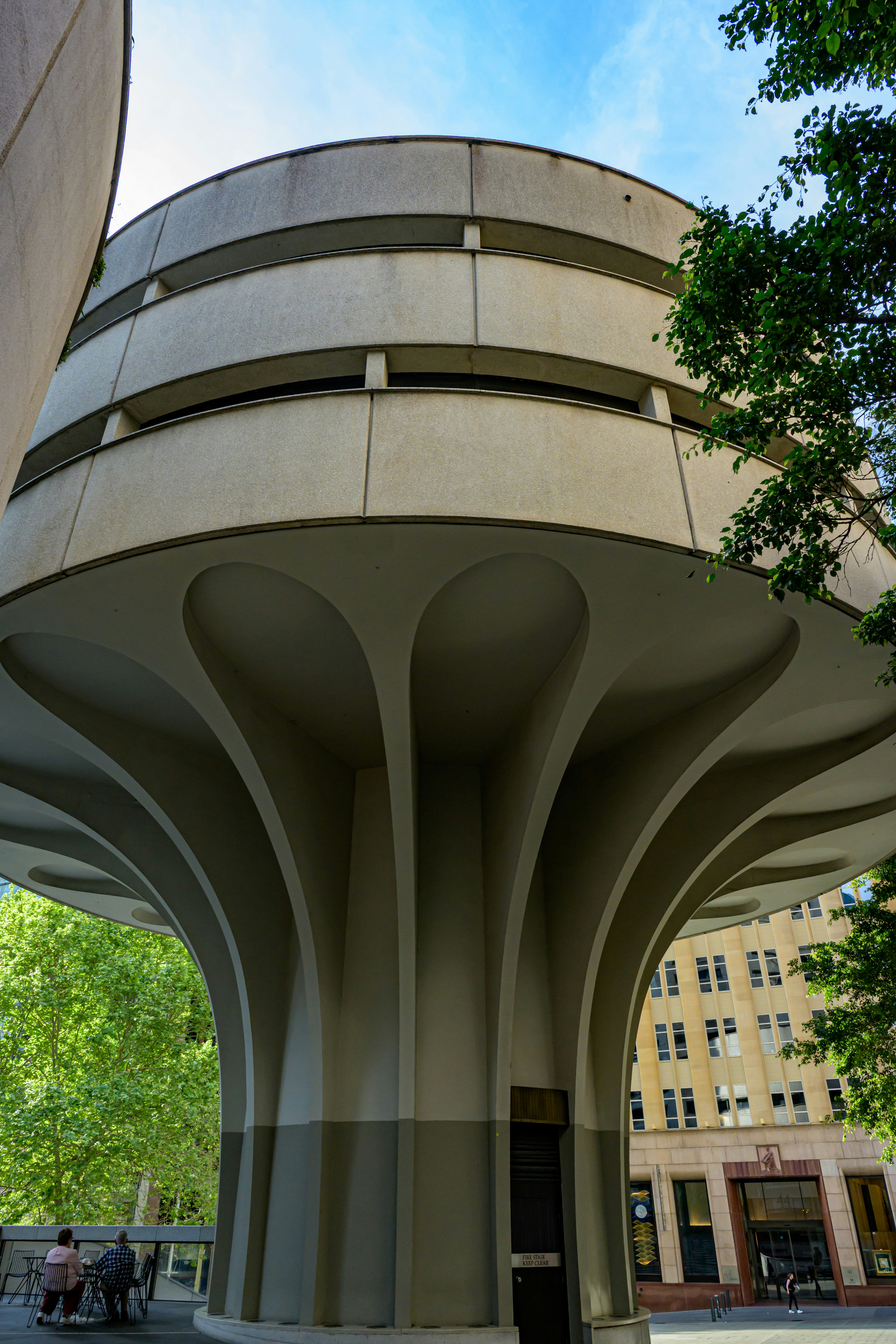 Unique concrete building with curved supports and balconies
