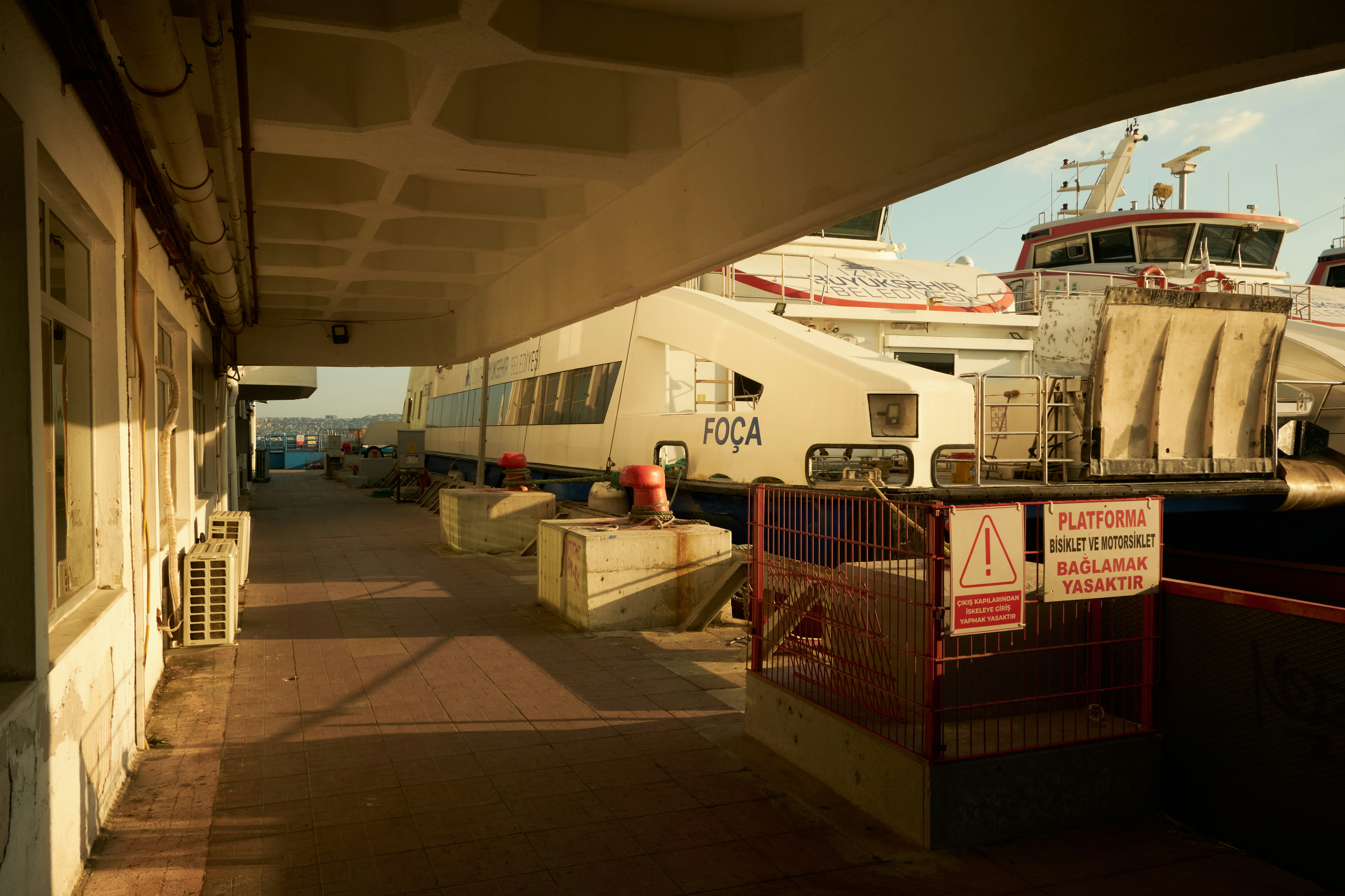 Modern ferry docked at a pier with cargo.
