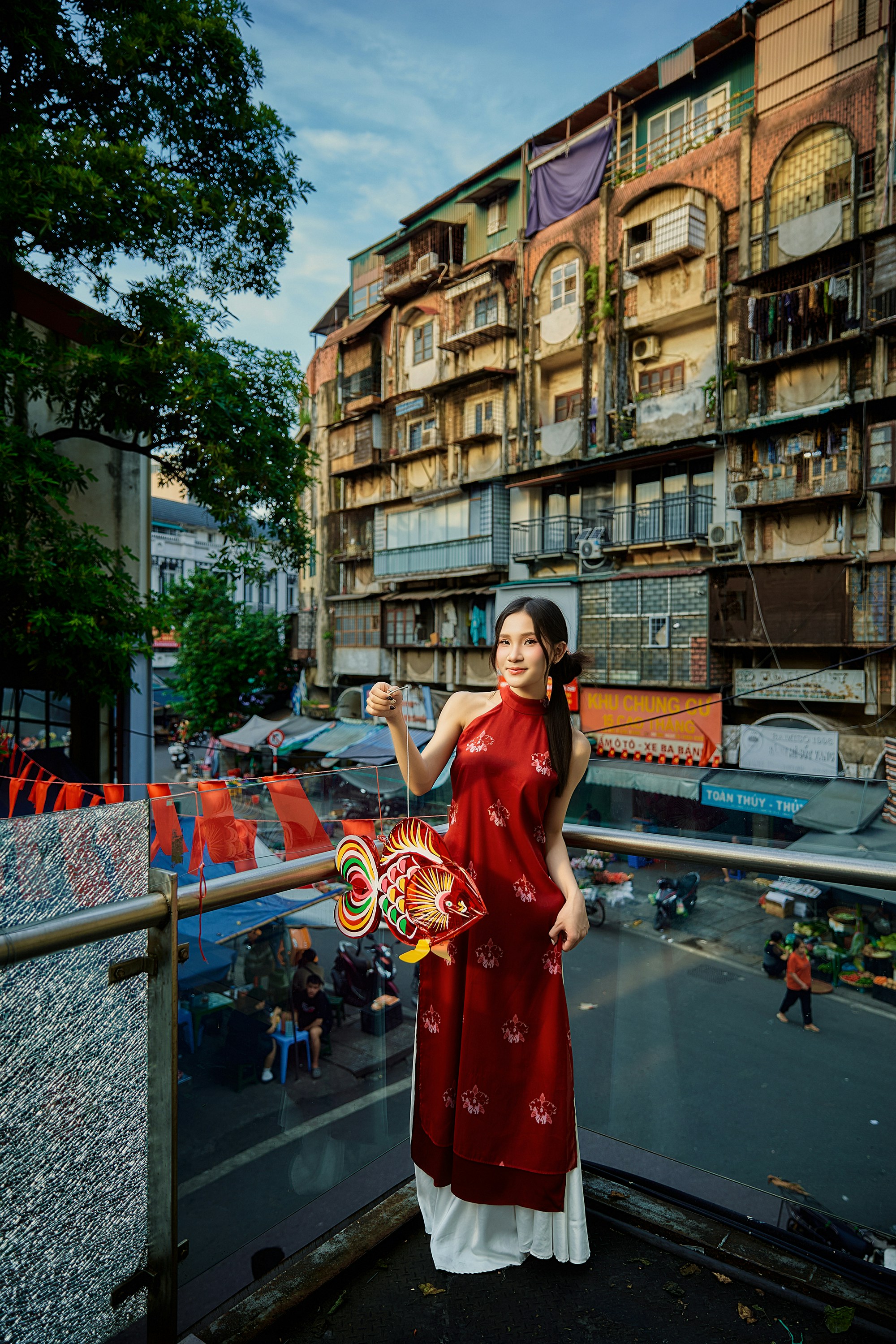 Crimson Cheongsam Portrait on a Balcony Over a Bustling Street Market