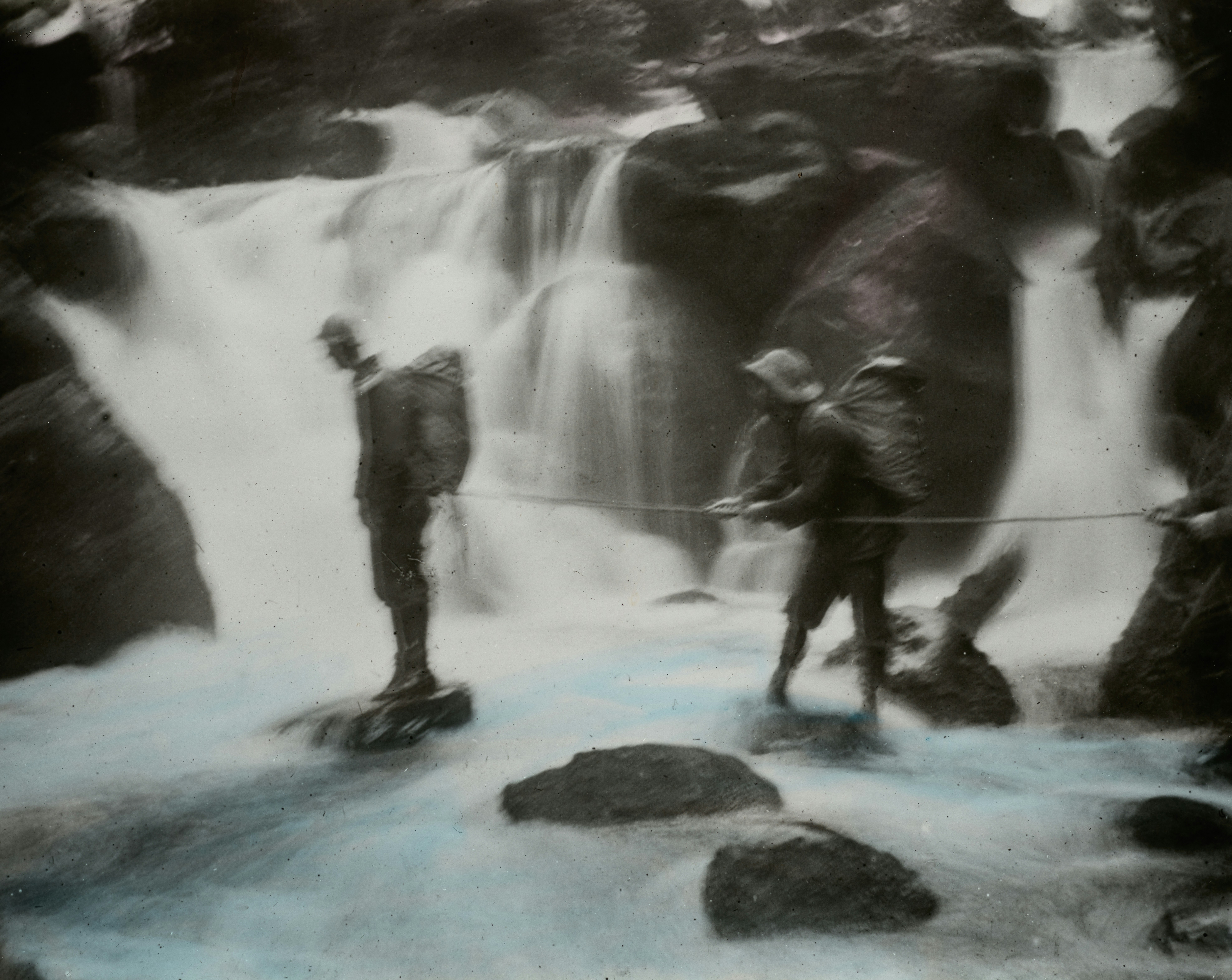 Across the Cascade: Rope Crossing Beneath a Turquoise Wake