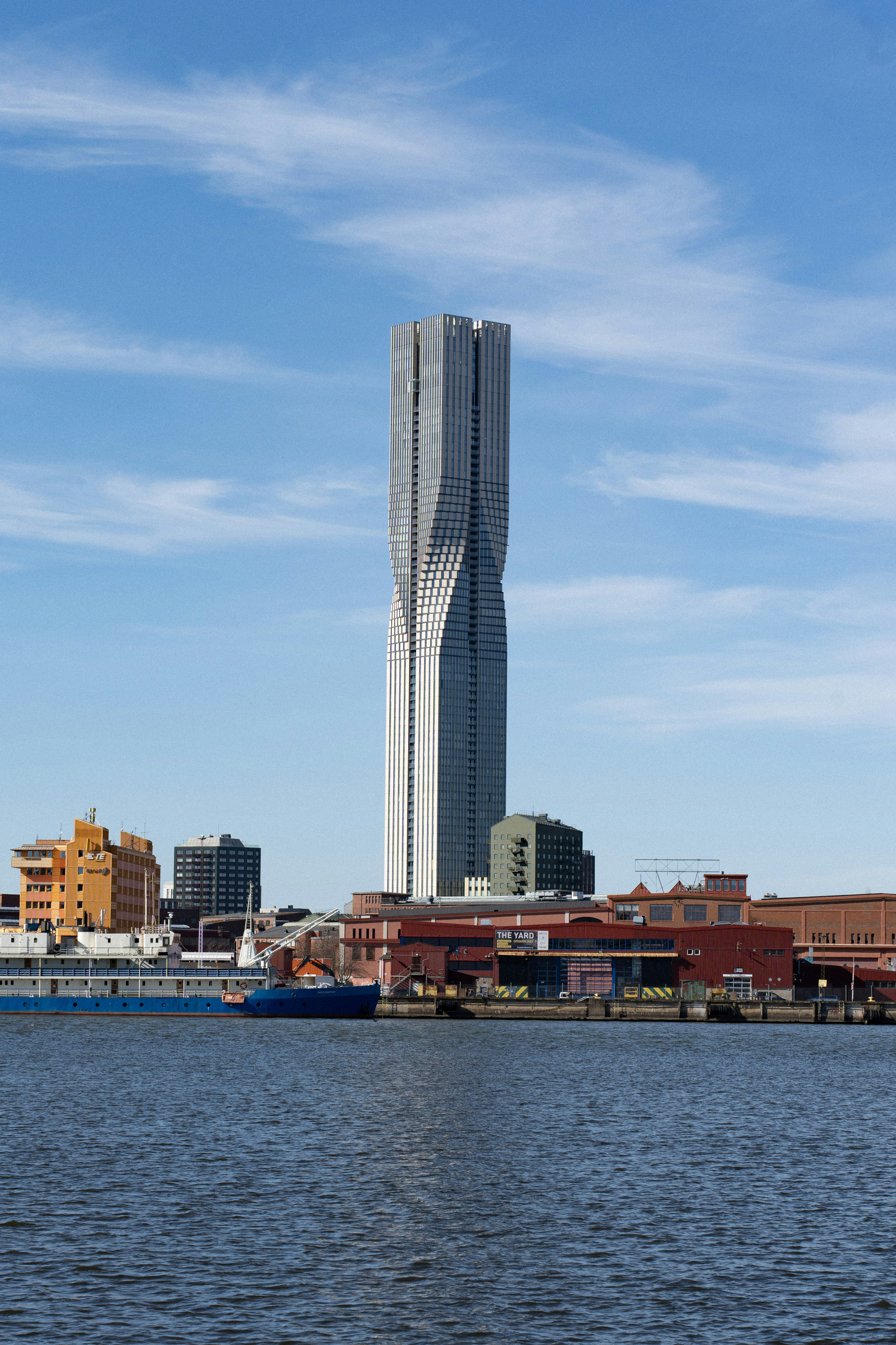 Modern skyscraper overlooking a waterfront cityscape