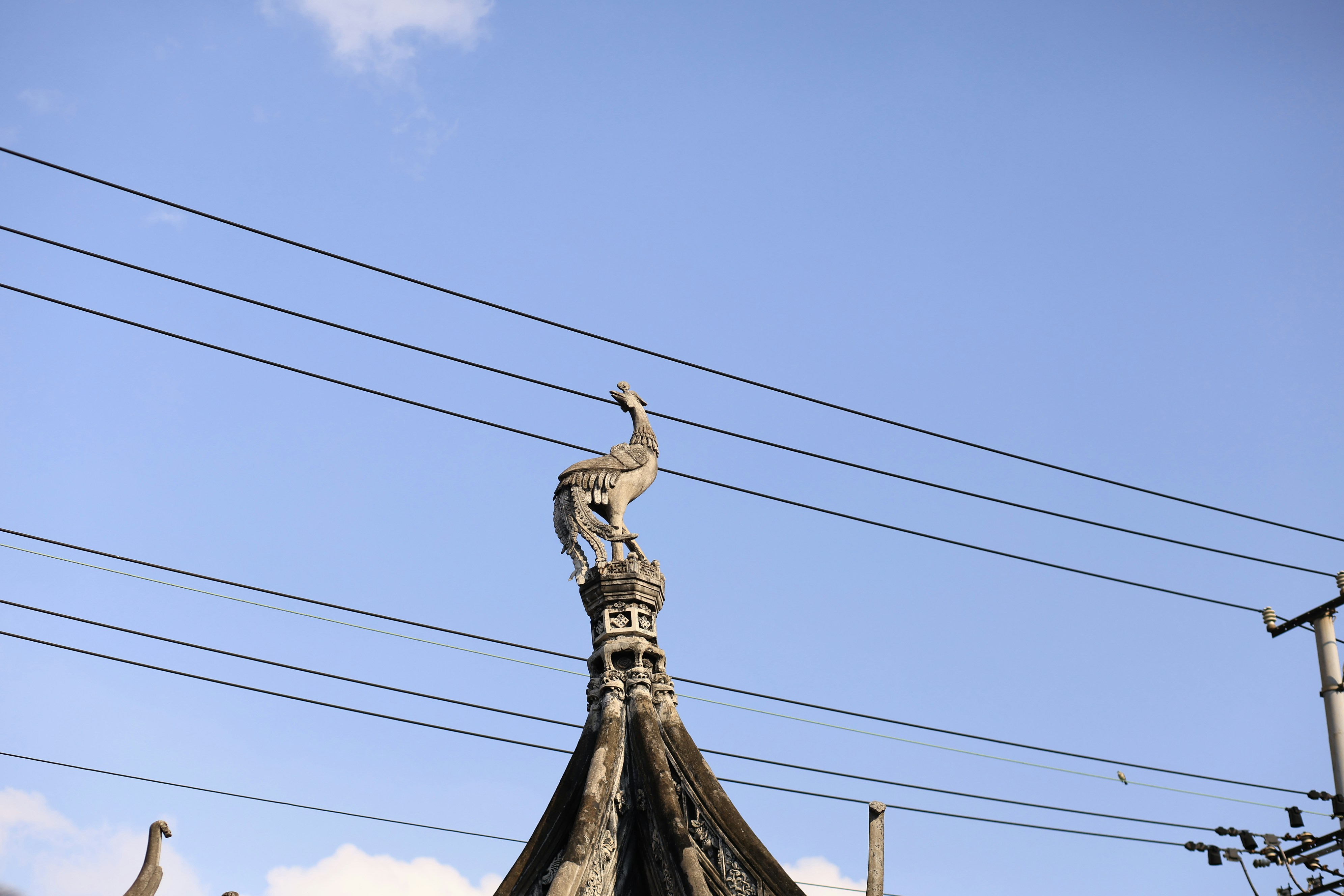 Blue Sky Sentinel: An Ornate Rooftop Crane Sculpture