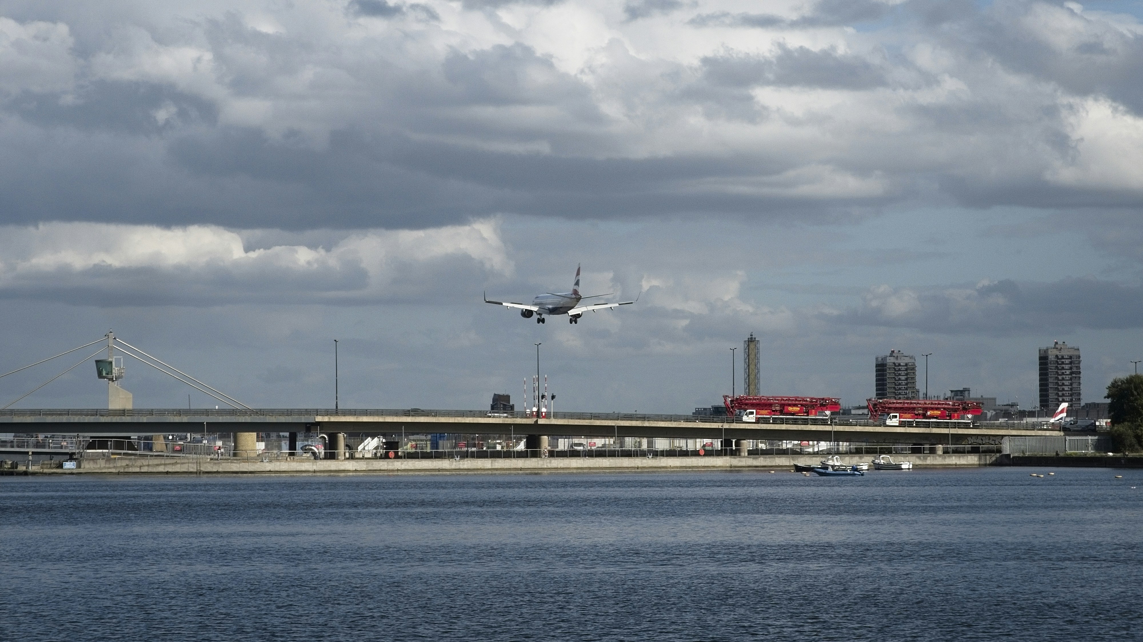 Approach over the River: A Plane Aligns with the City Bridge