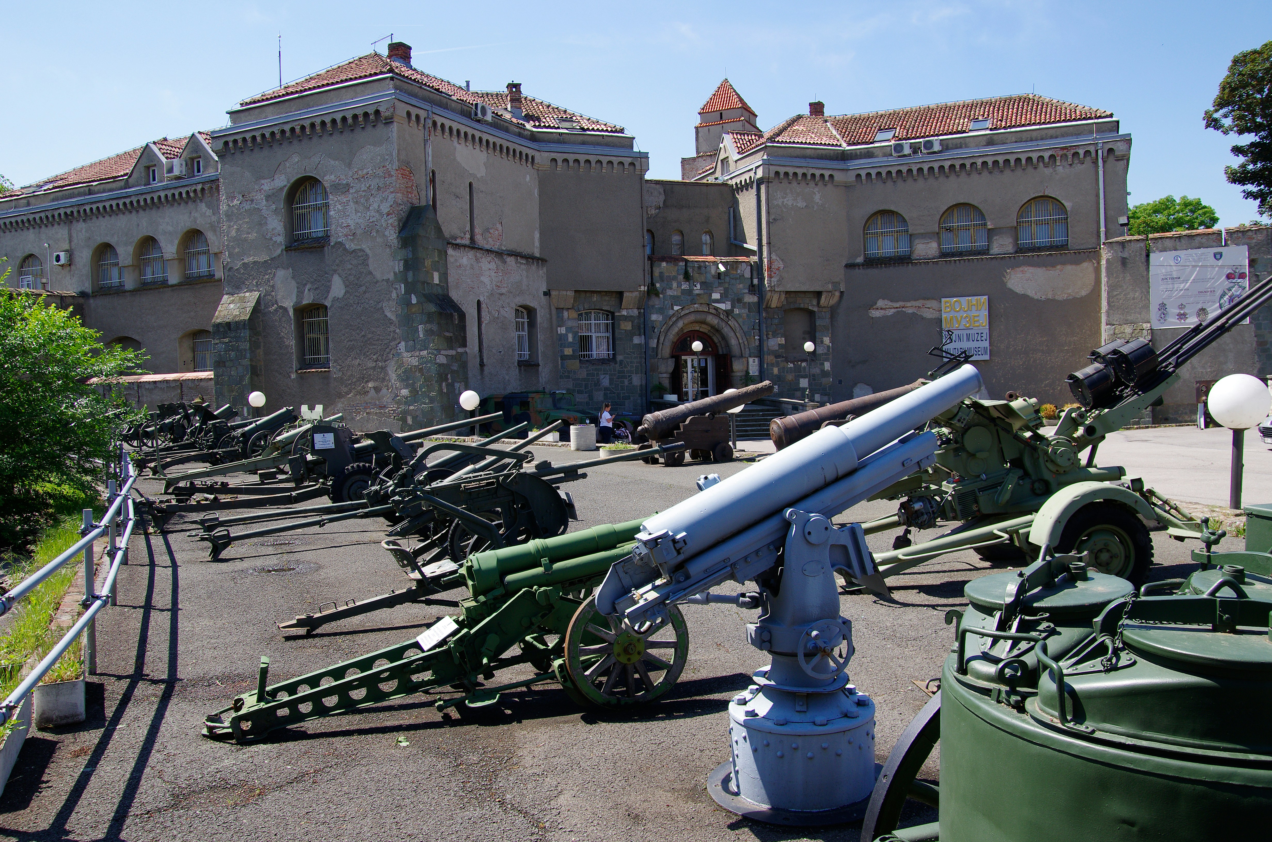 Collection of historical artillery pieces arranged outside a military museum, showcasing their intricate designs and historical significance.