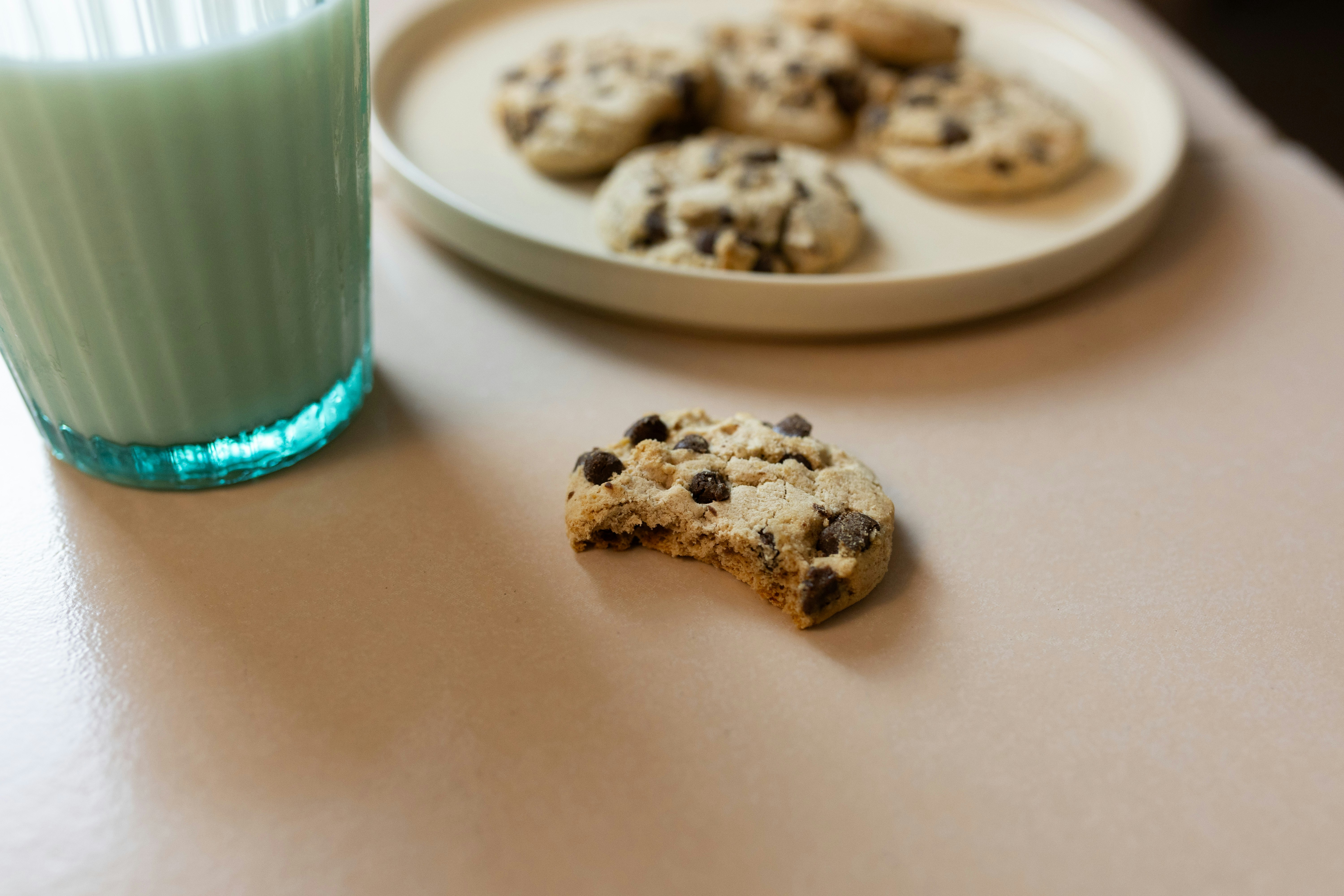 Chocolate chip cookie with a bite taken out.