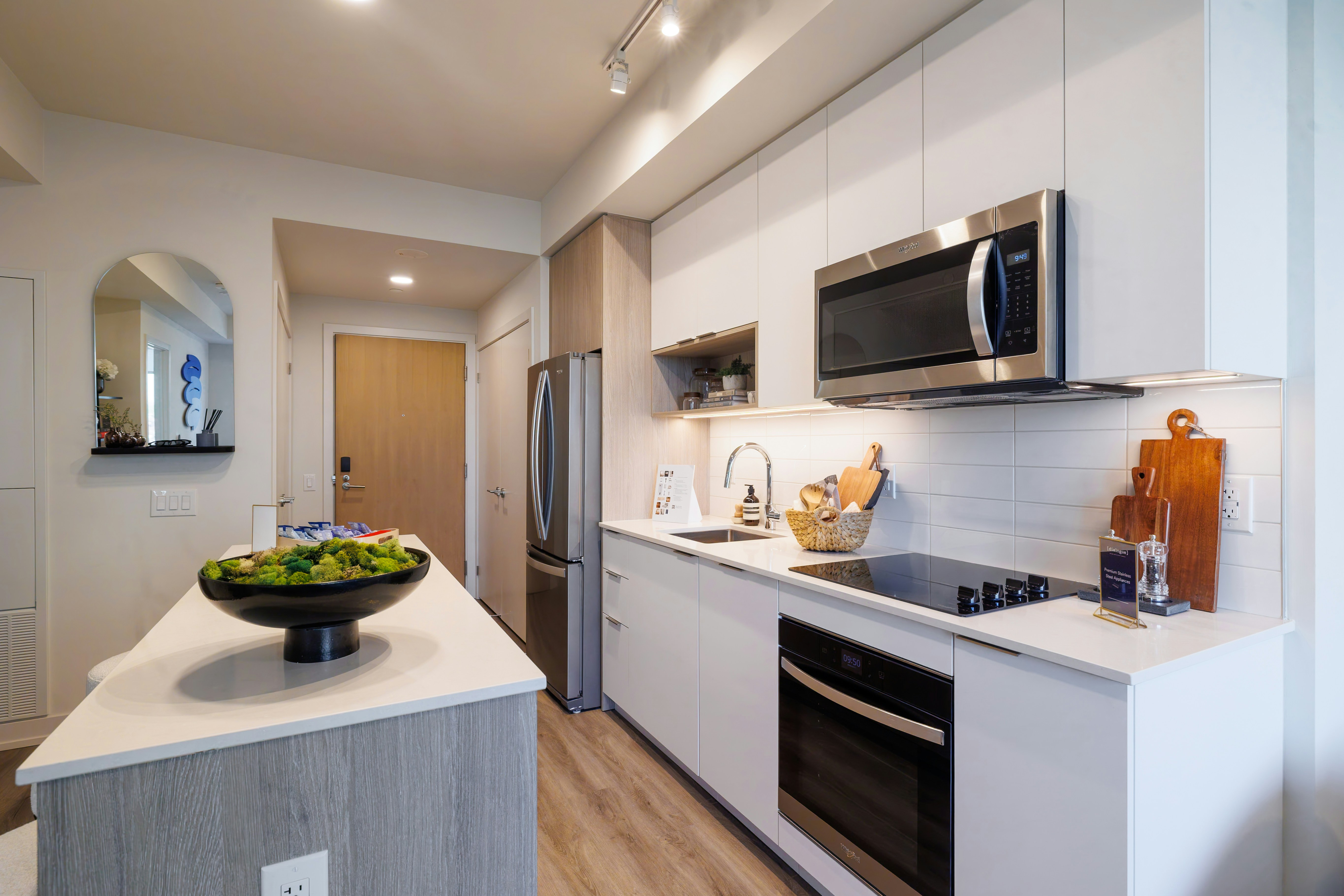 Modern kitchen with stainless steel appliances and island.