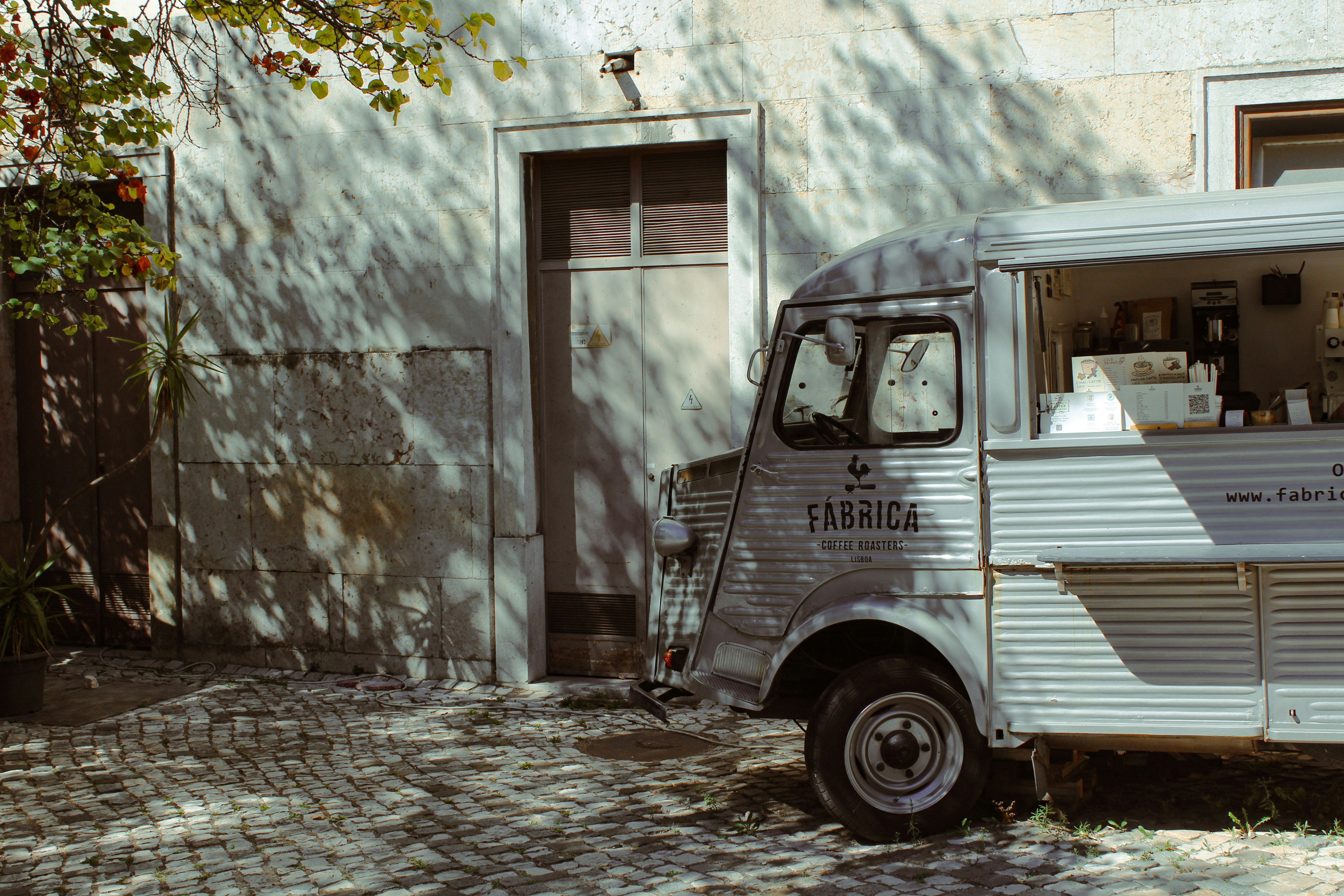 Vintage food truck parked outside a building.