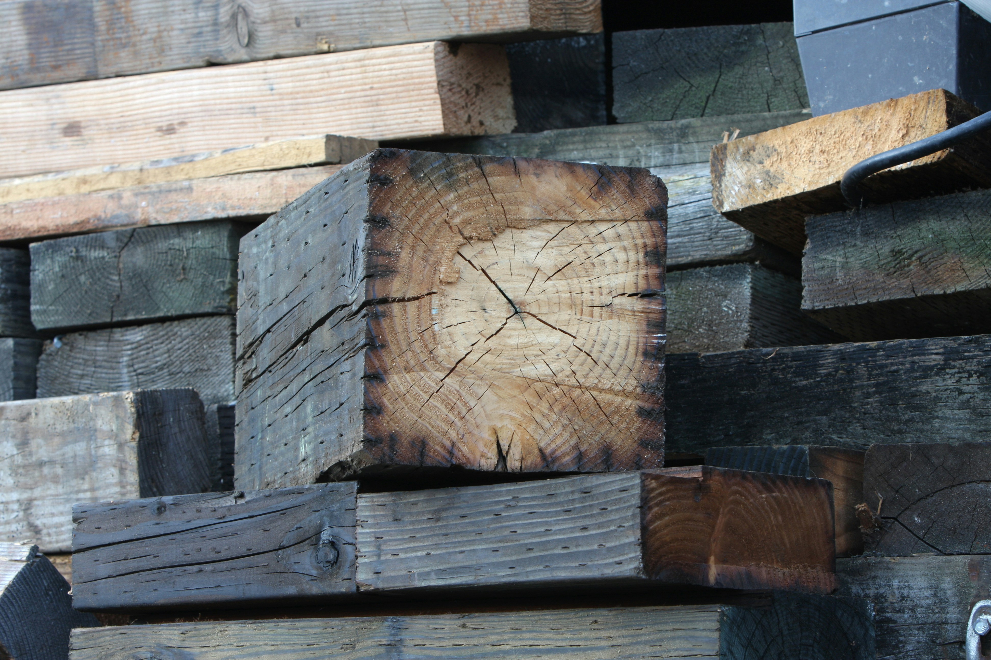 "Lumber" --- Close-up of cut lumber. | Stack of weathered wooden beams with visible grain.