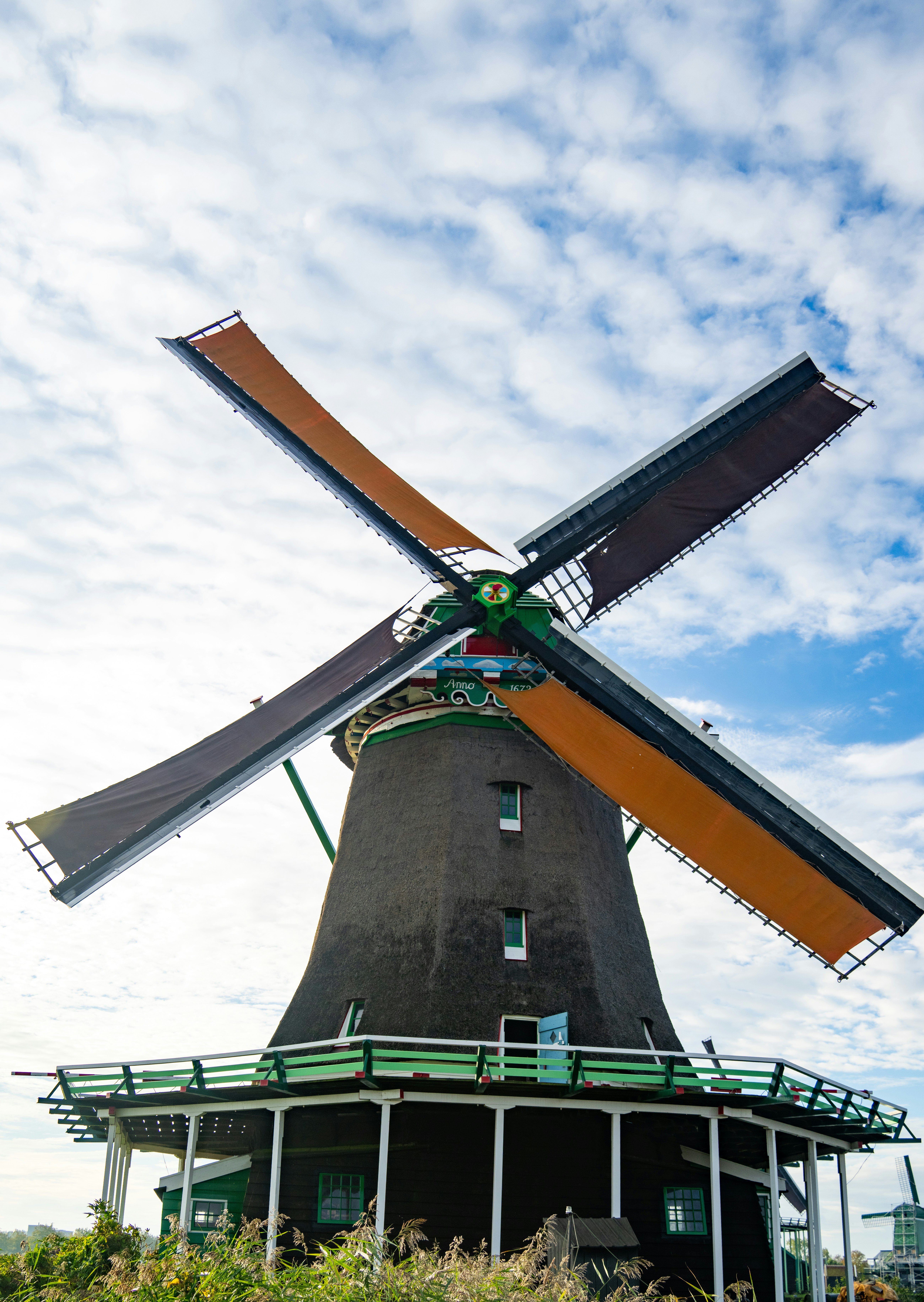 Quadruple Arc: The Windmill's Four Arms Span a Clear Sky