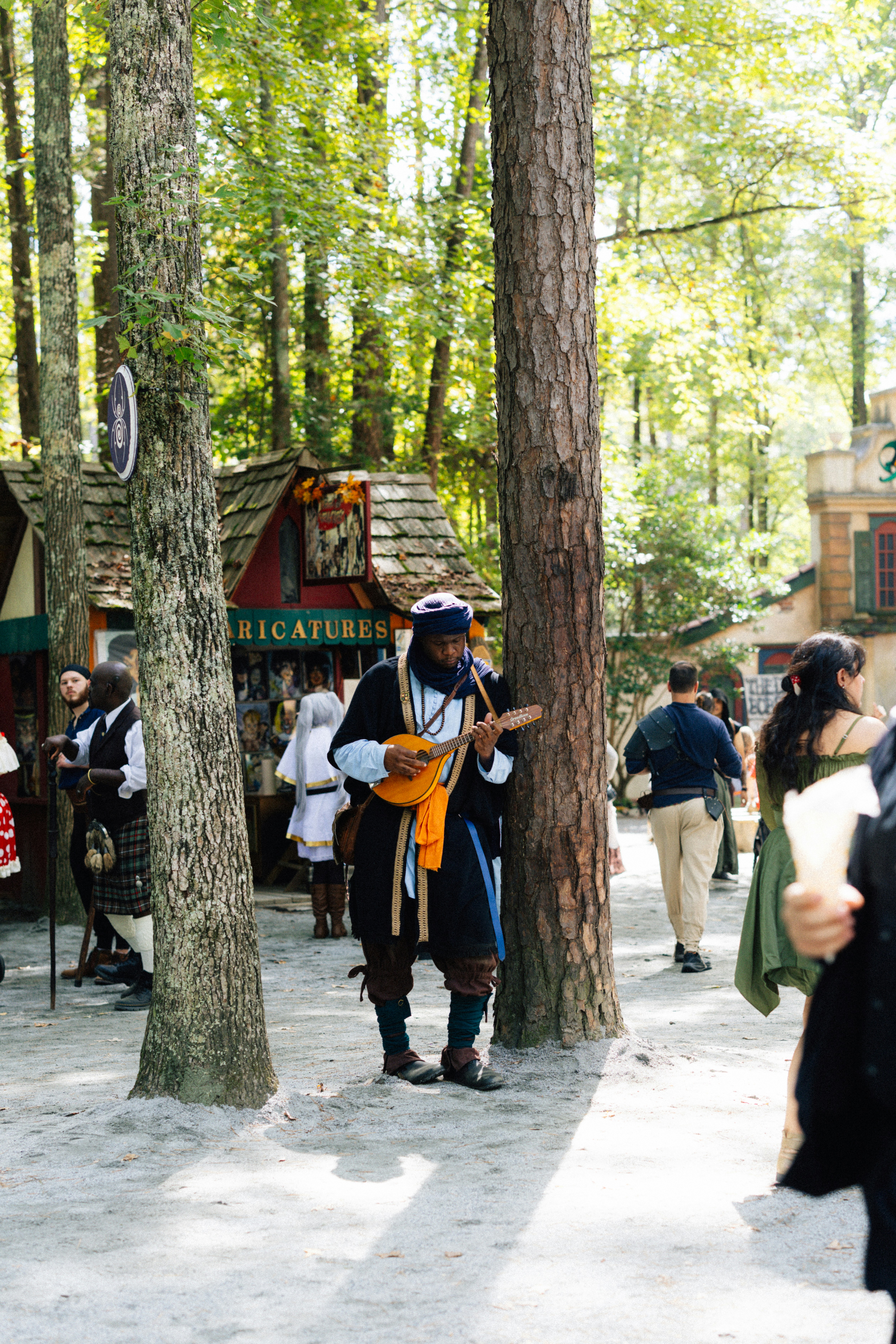 Guitarist in a Shaded Square Weaves Melodies Between Trees