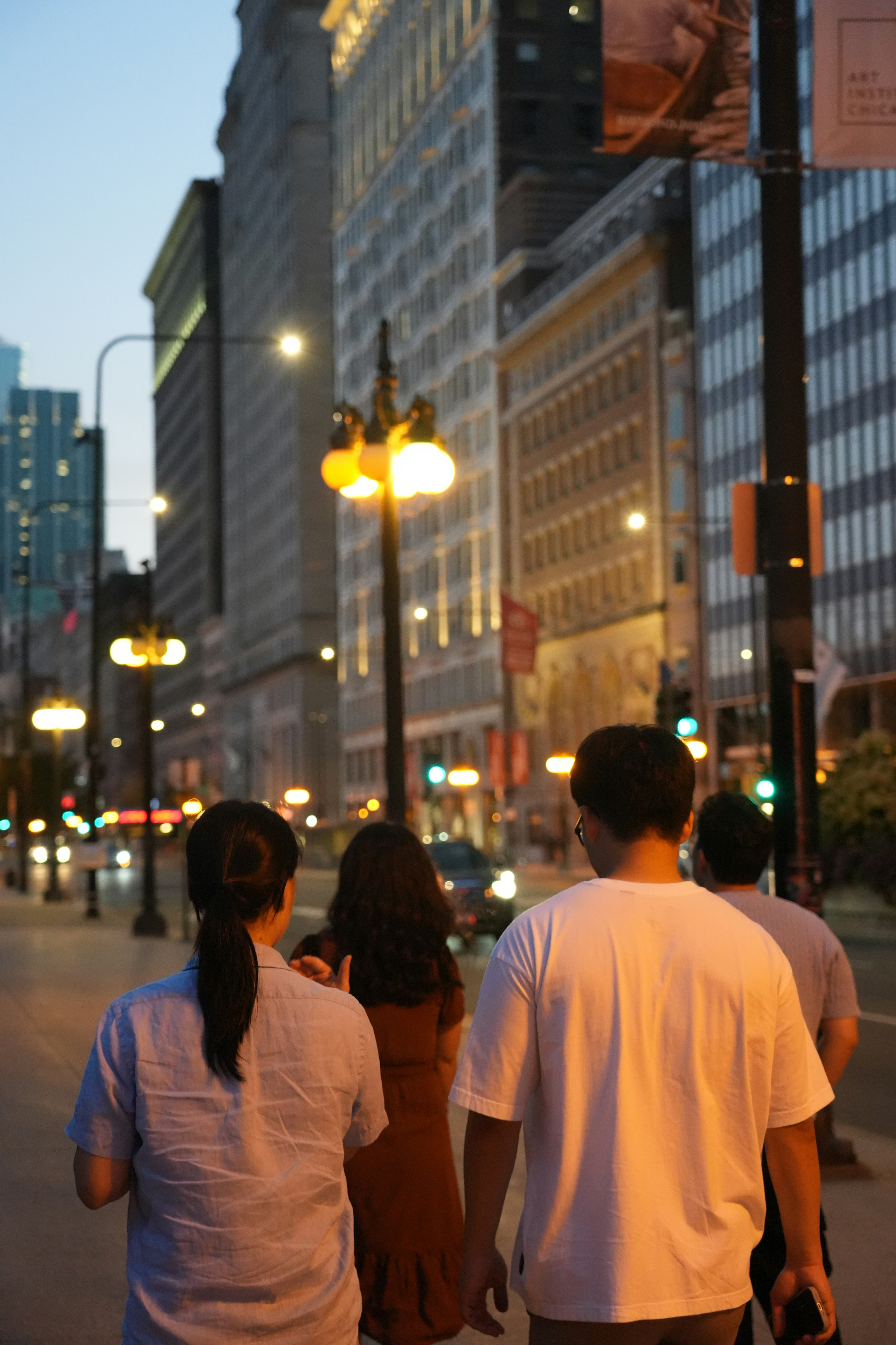 chicago | People walking down a city street at dusk.