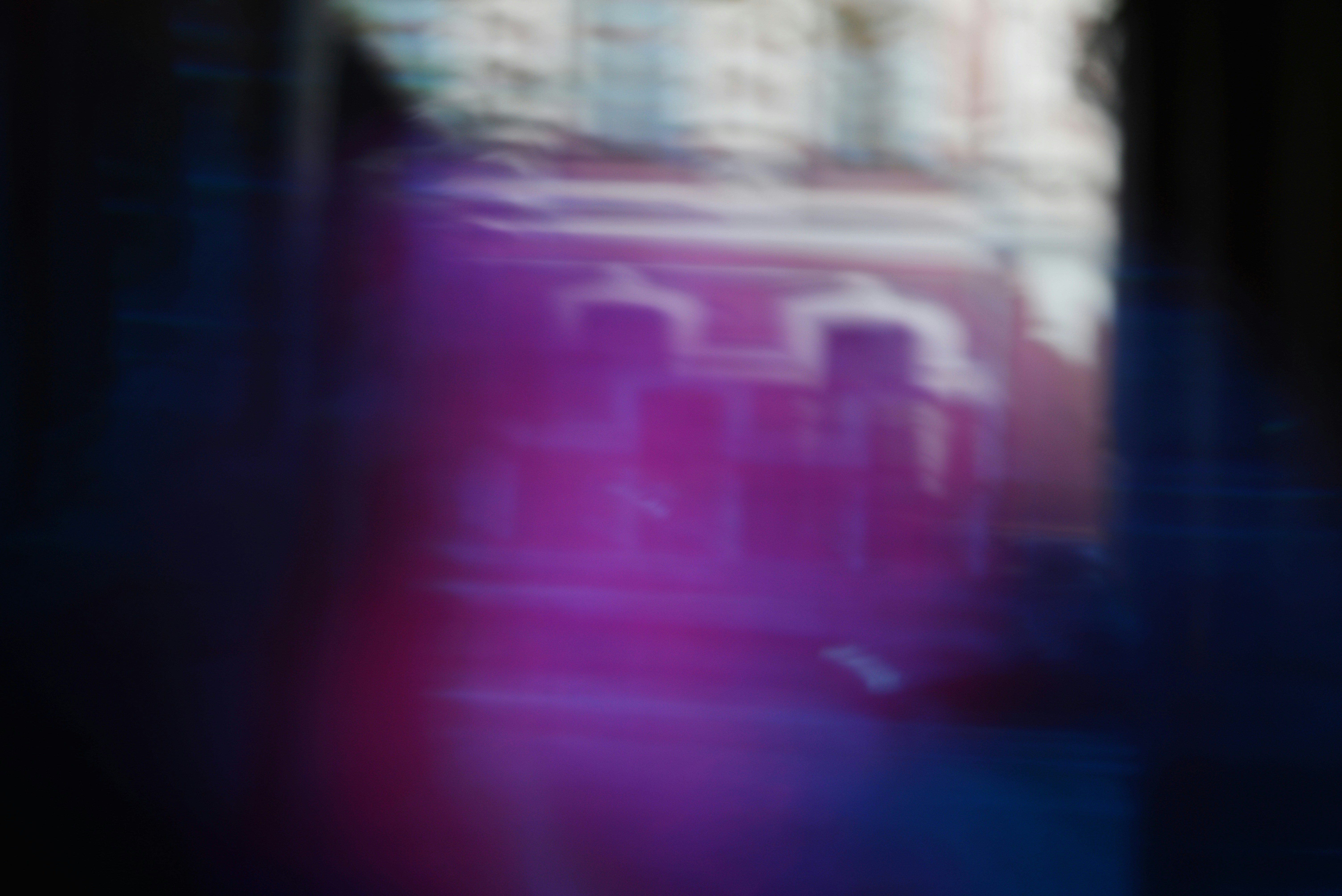 Blurred building facade with purple and blue light