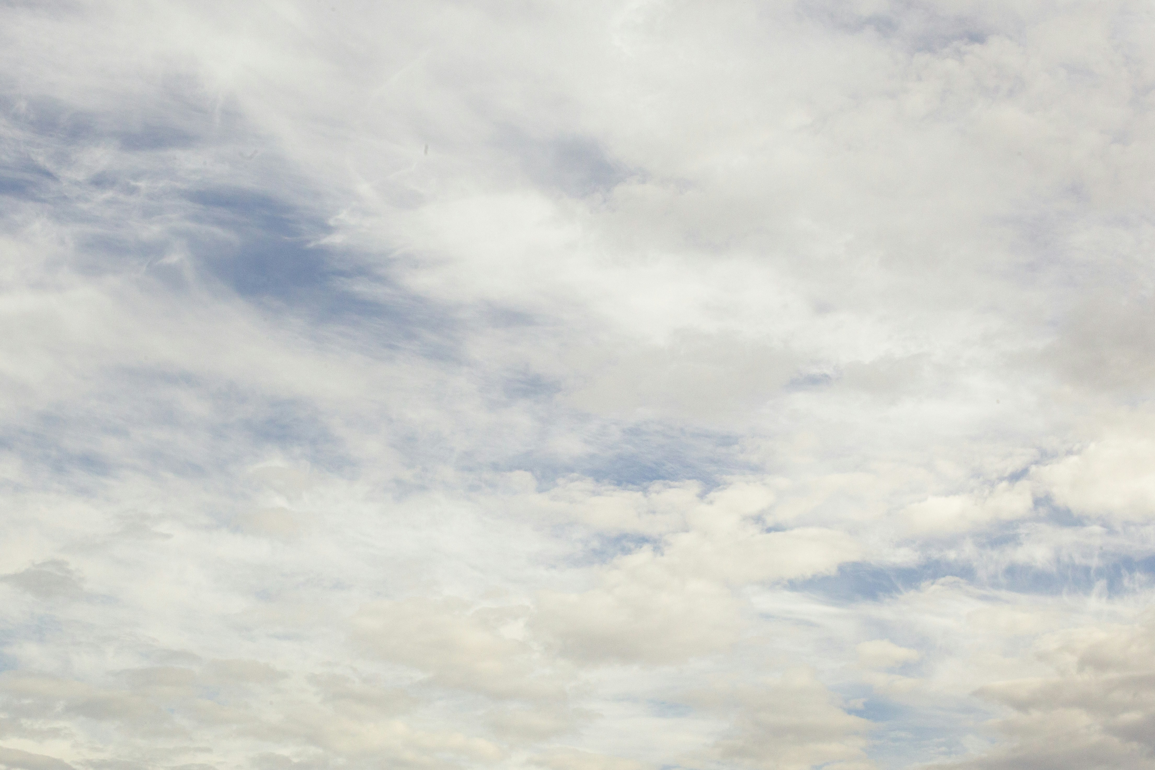 Wispy clouds drift across a blue sky.