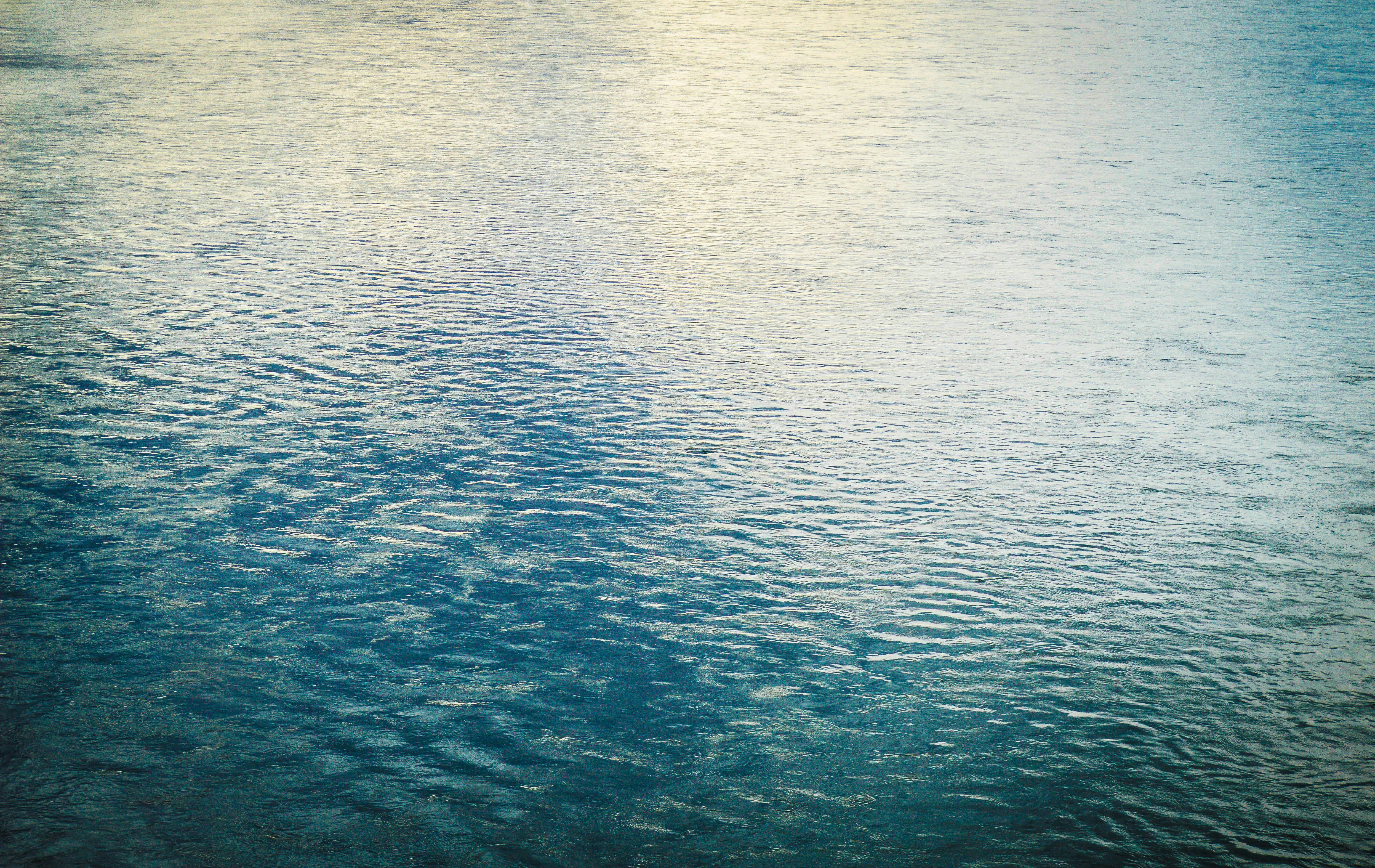 Rippling blue water surface with light reflections