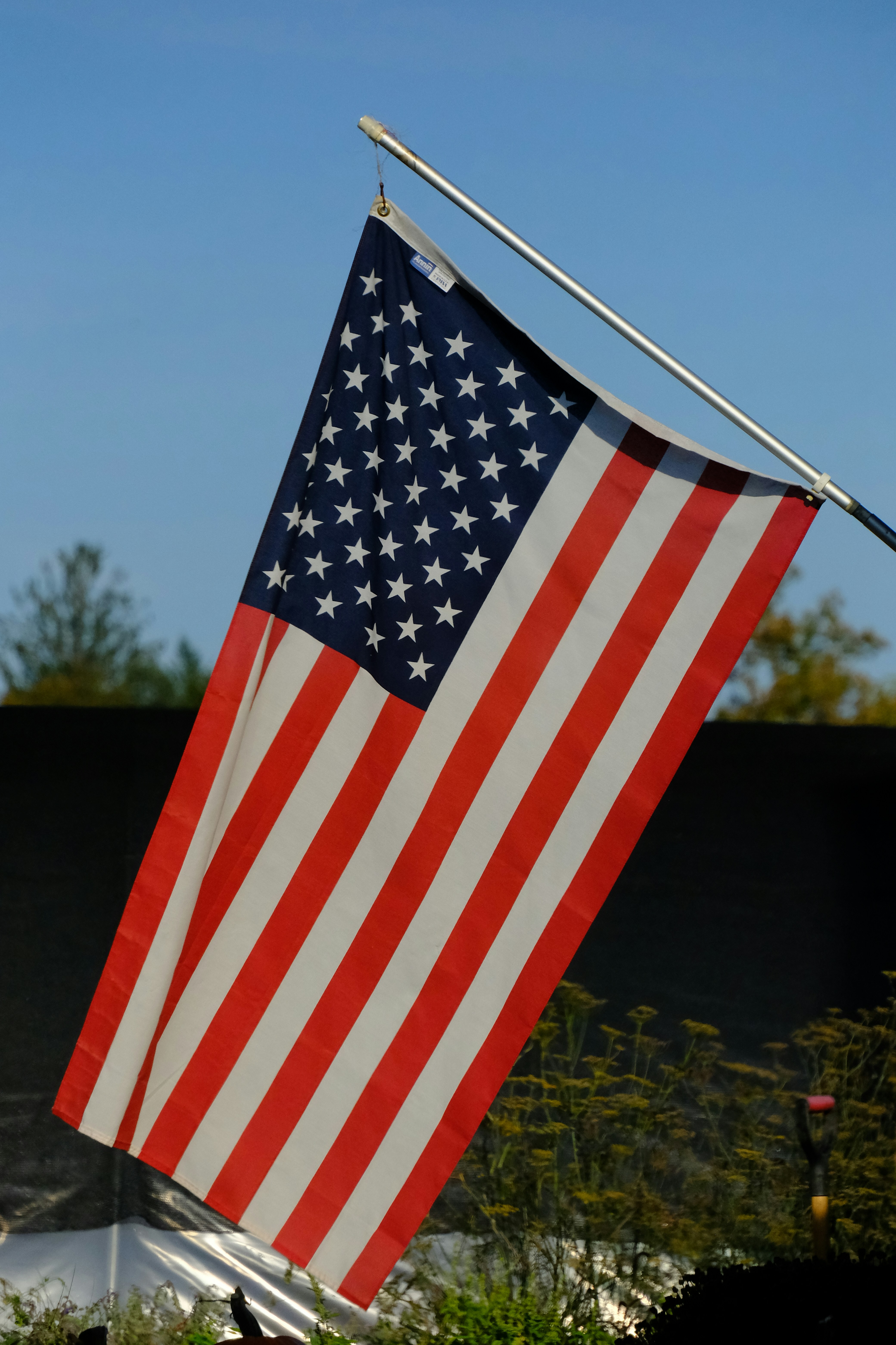 American flag waving against a blue sky