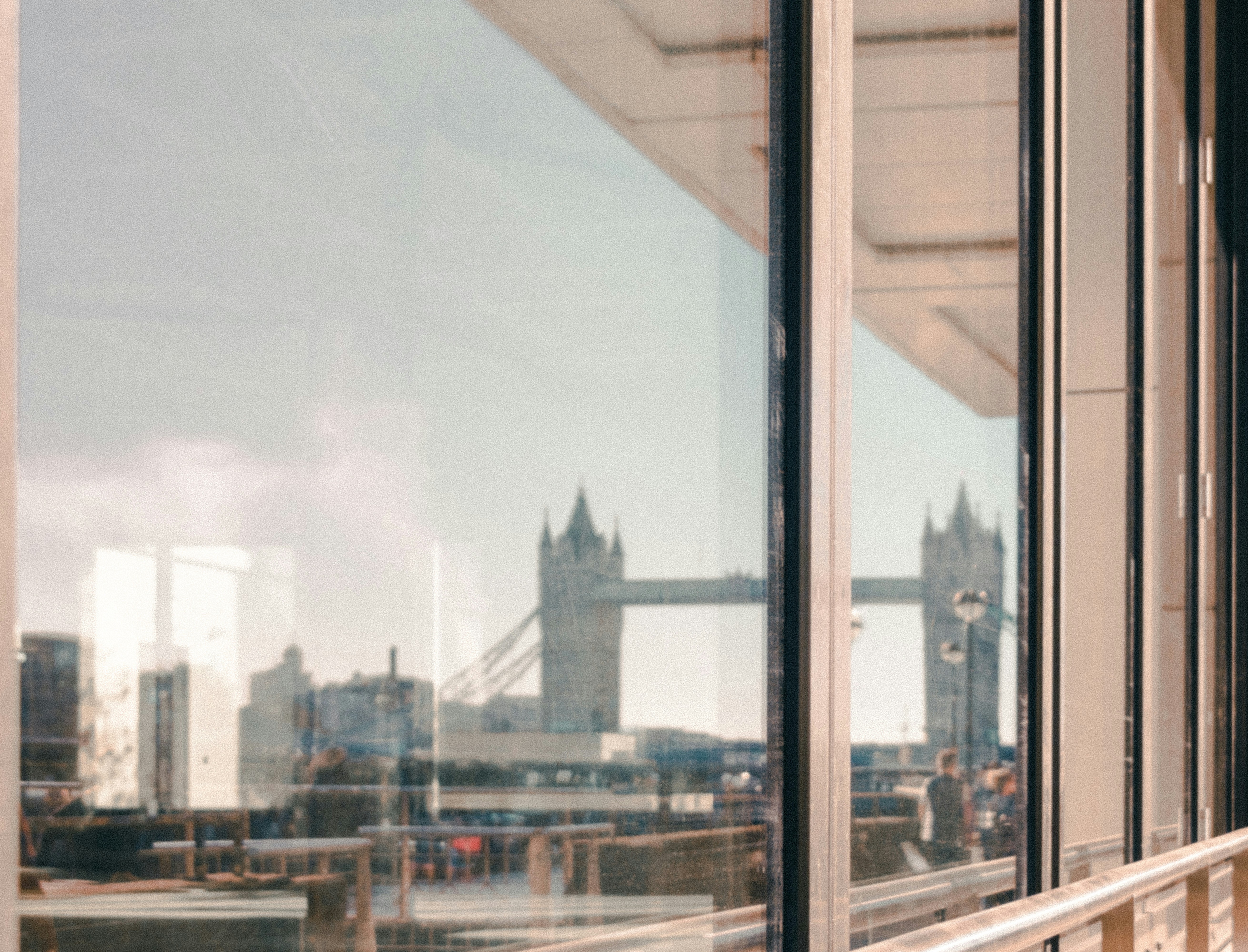 Tower bridge reflected in a modern building window