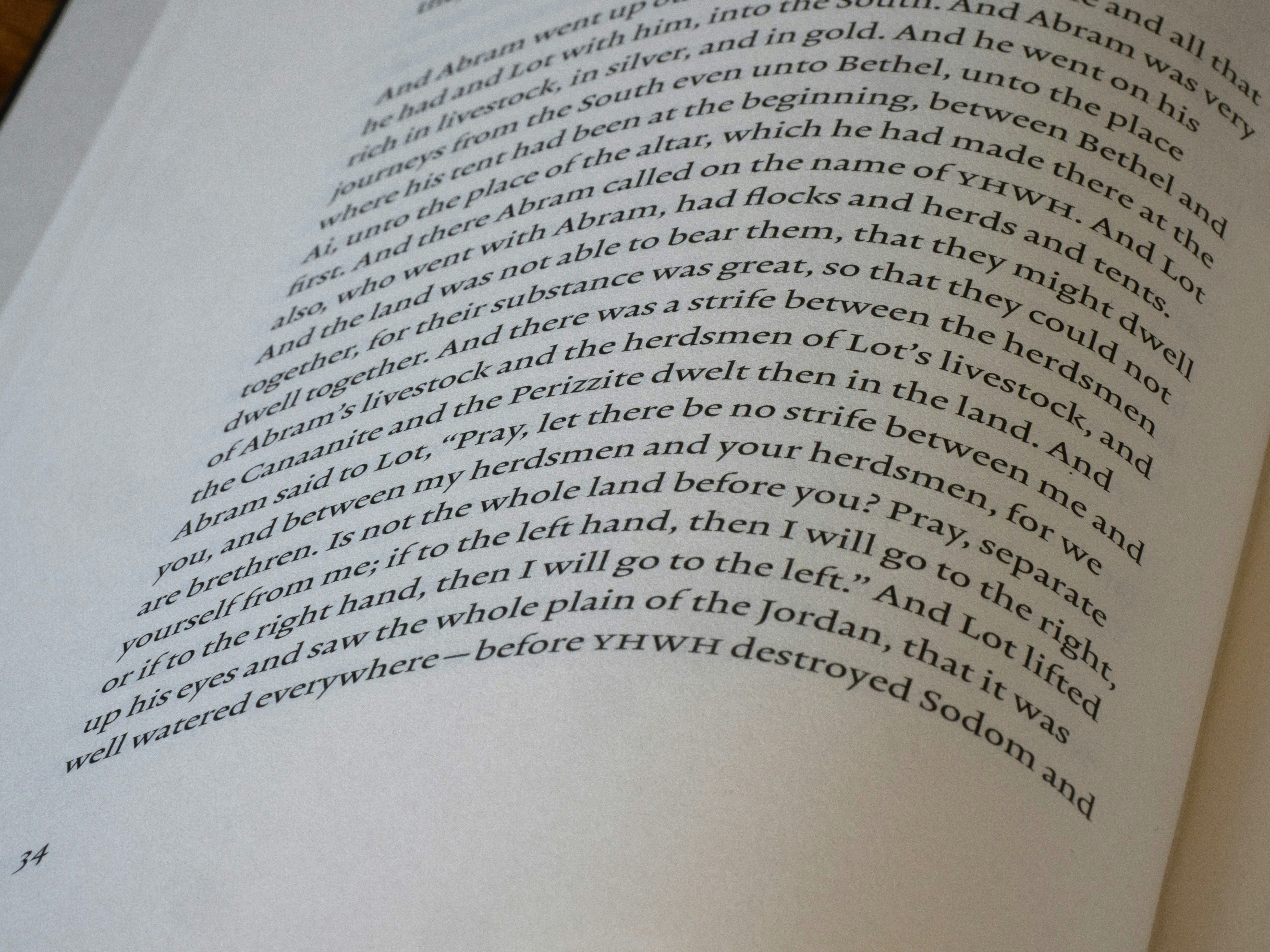 Text from a biblical passage discussing the separation of land between Abram and Lot. The focus is on the dialogue and decision-making depicted in the scripture.