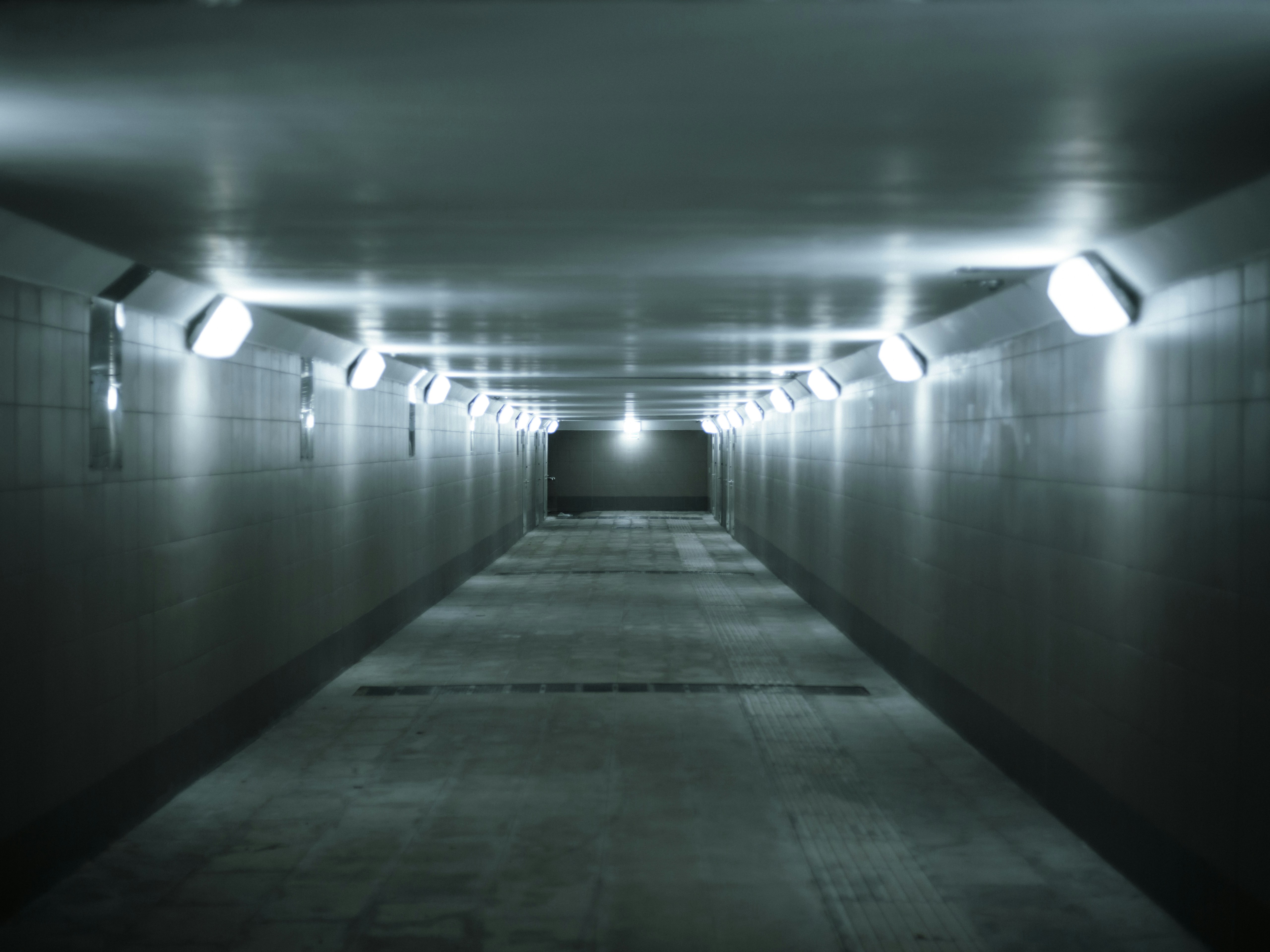 Illuminated pedestrian tunnel with overhead lights