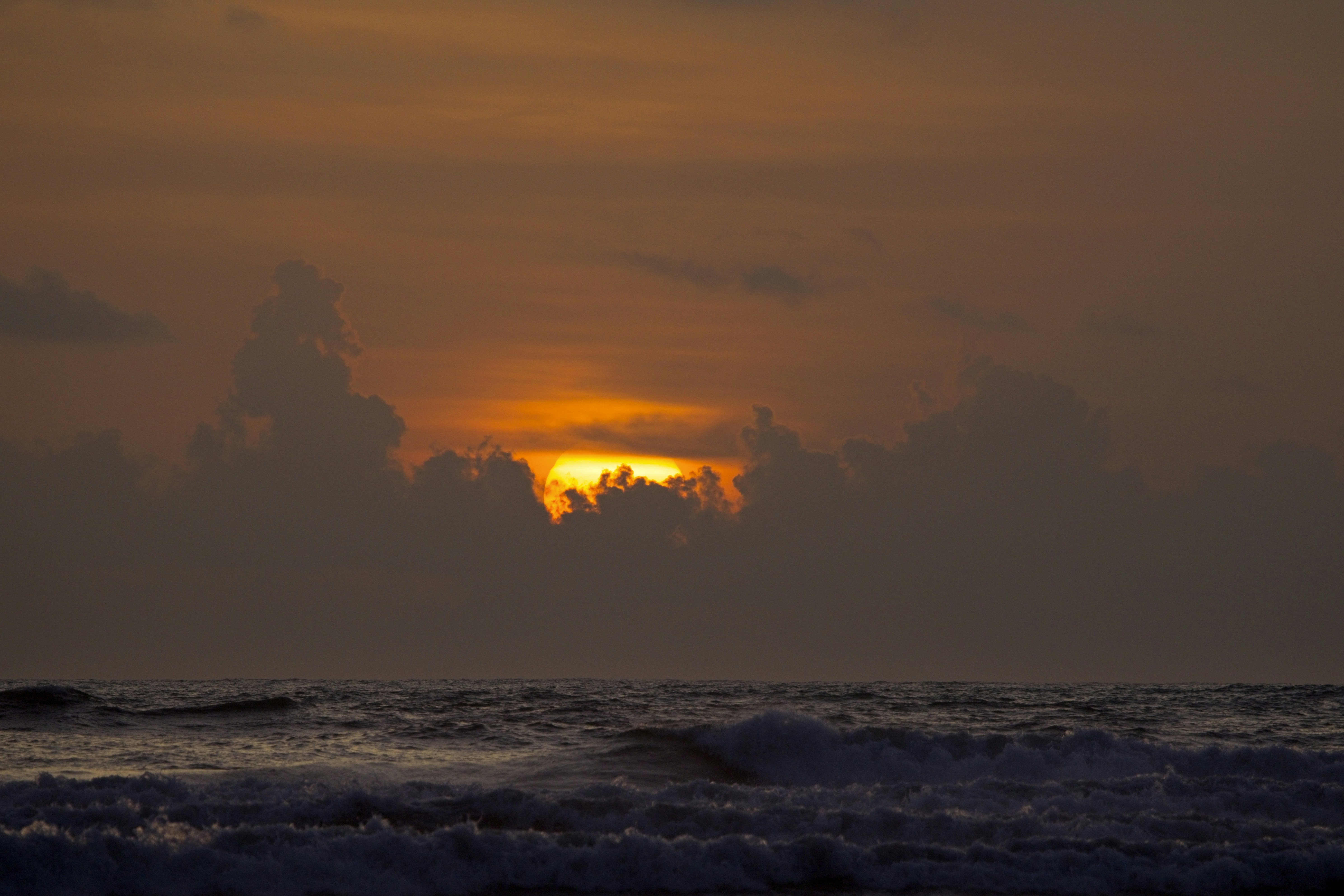 Sunset over the ocean with clouds