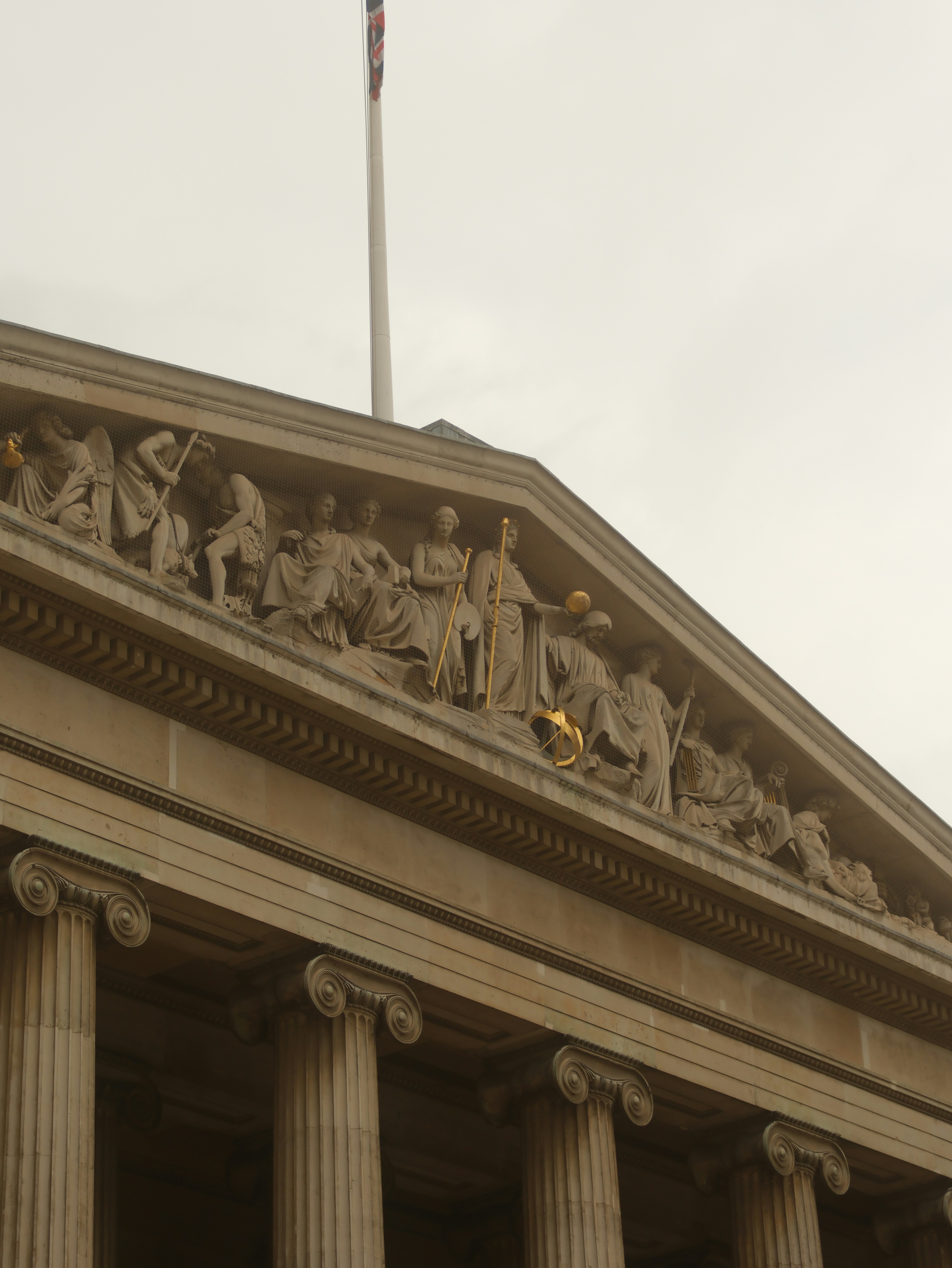 Stone Paragons: A Frieze of Statues Under an American Flag
