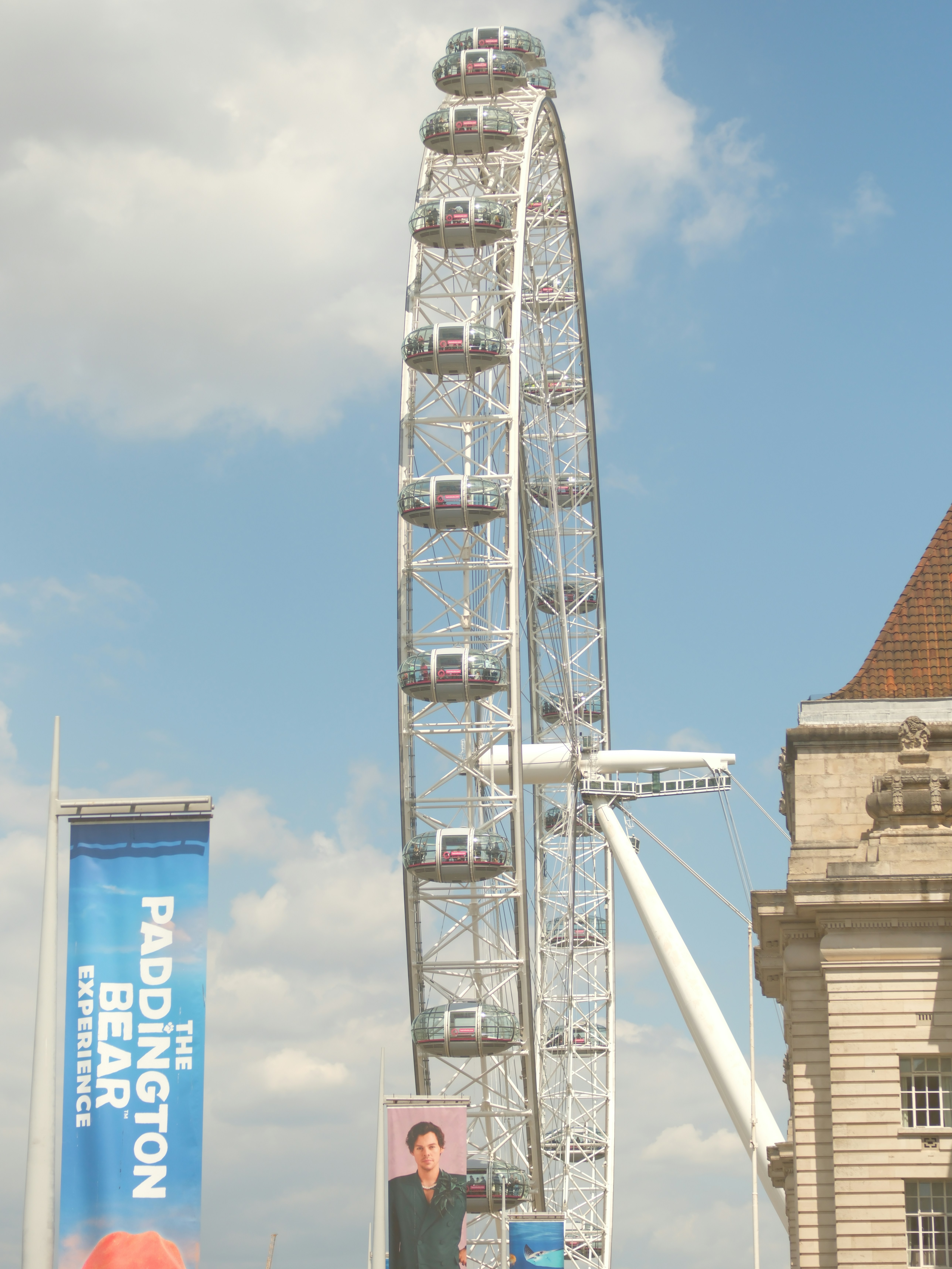 The london eye observation wheel against a blue sky.