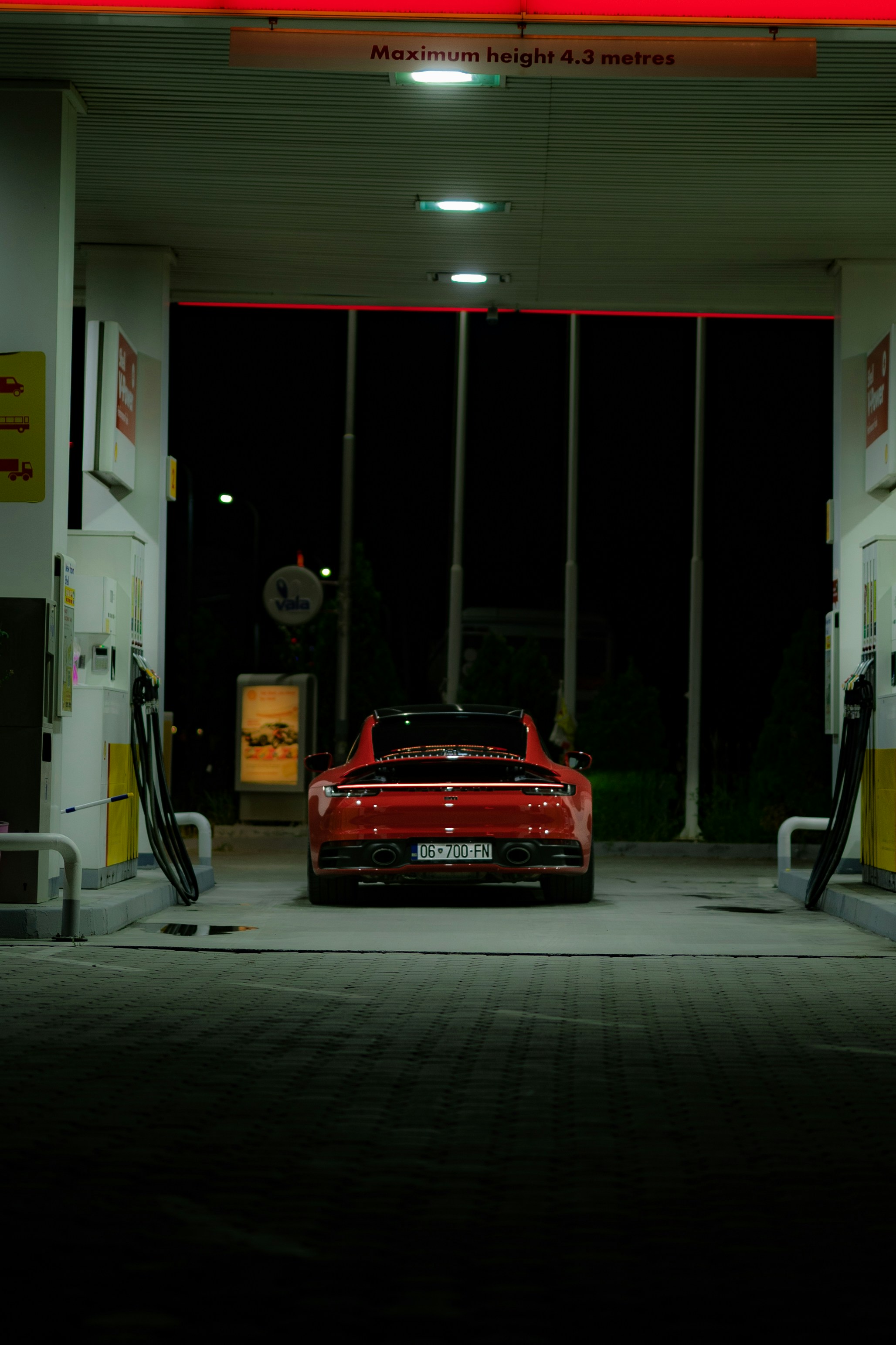 Crimson Classic Under Neon Night at a Quiet Fuel Stop