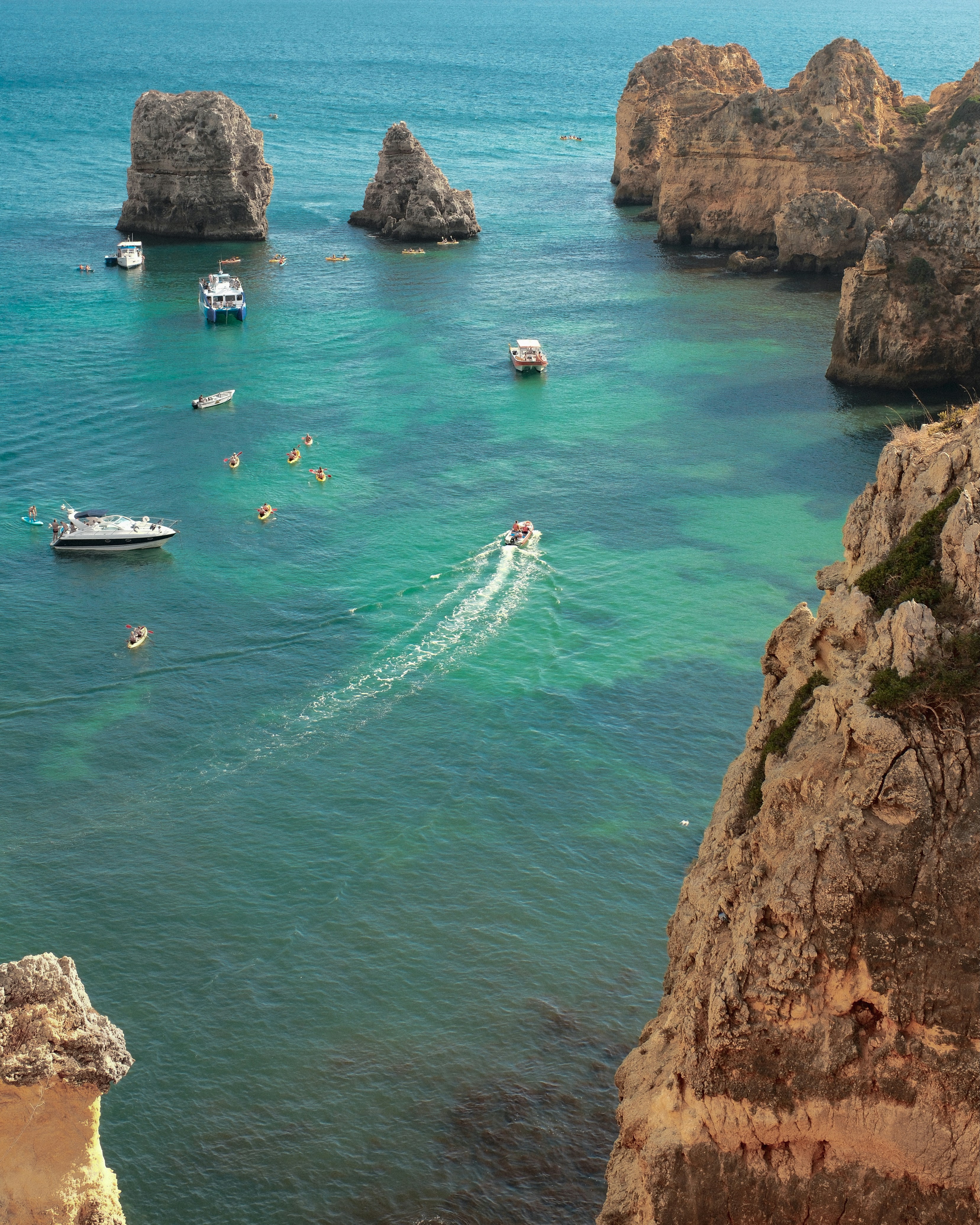 Emerald Cove: Boats, Waves, and Sunlit Cliffs