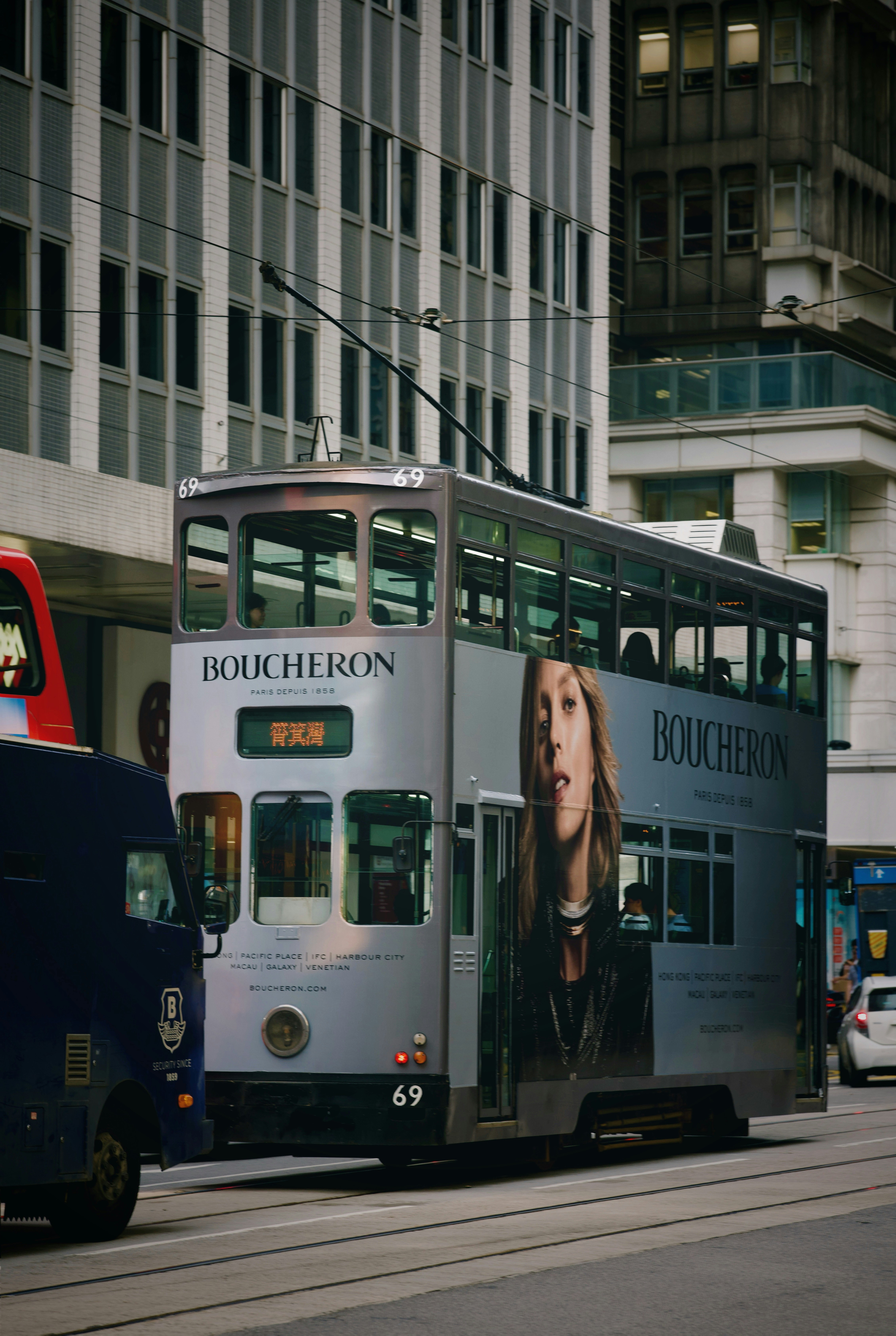 Double-decker tram with advertisement on side.