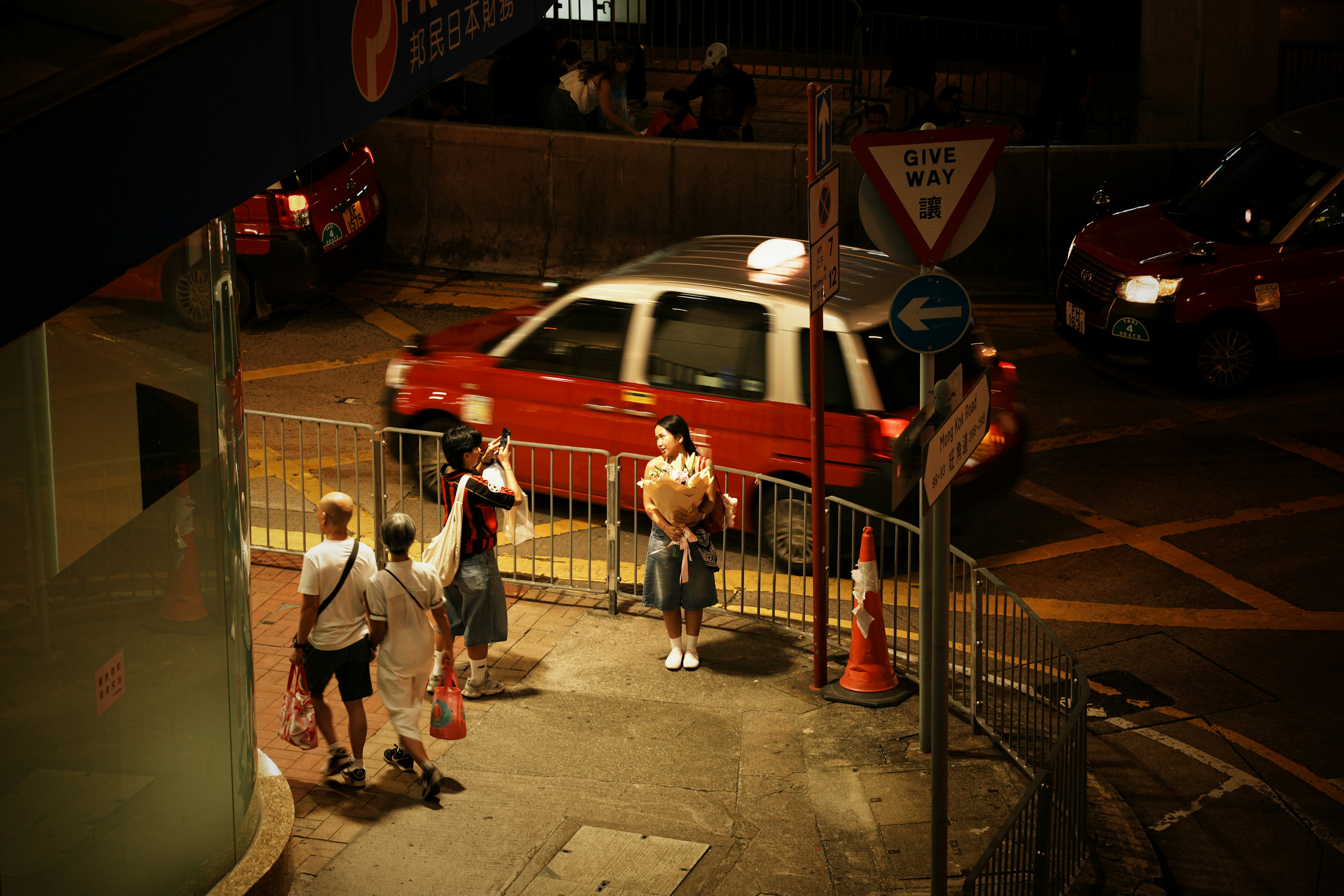 Night Crossing by the Barrier: Pedestrians and a Passing Taxi