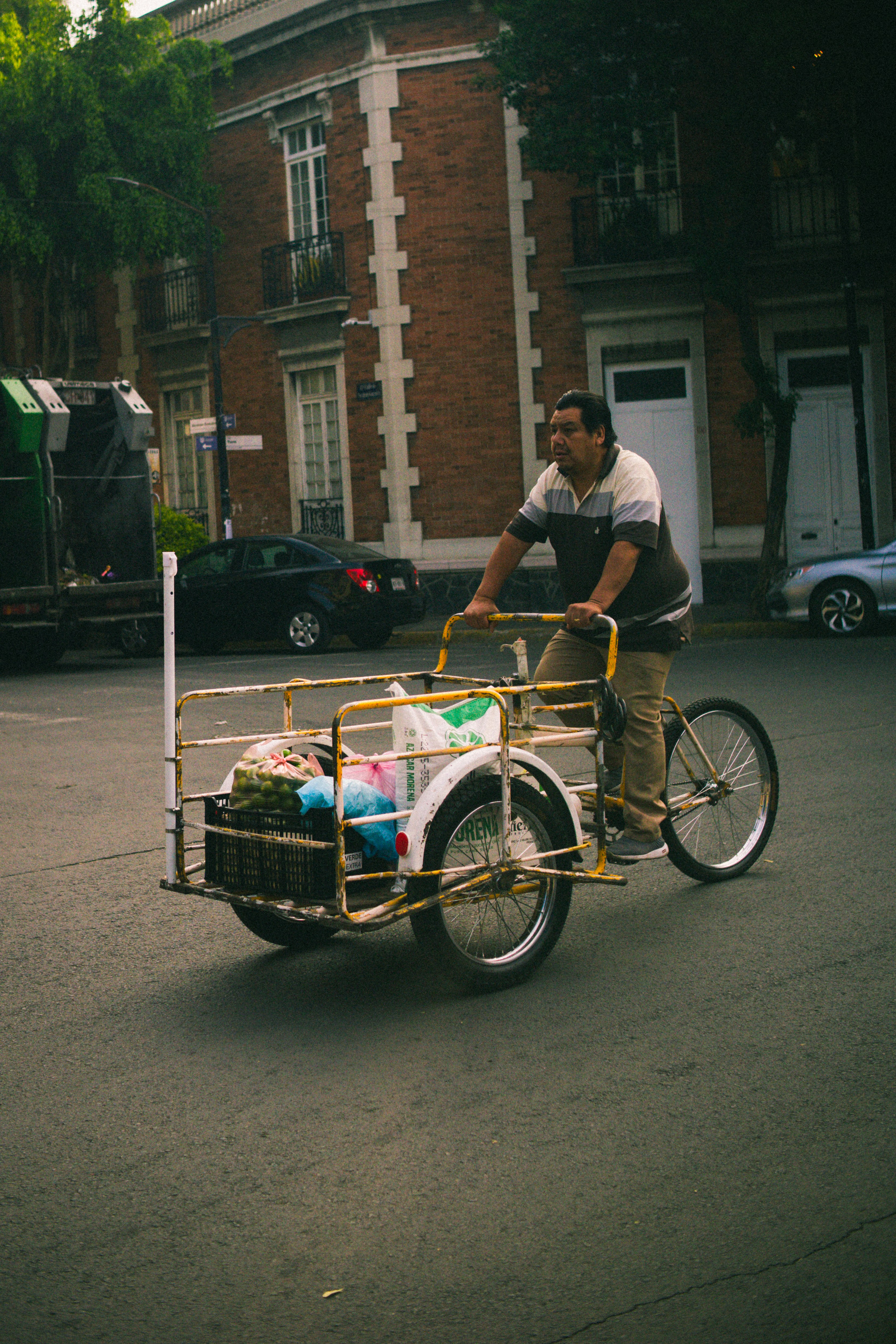 Man riding a cargo bicycle with goods