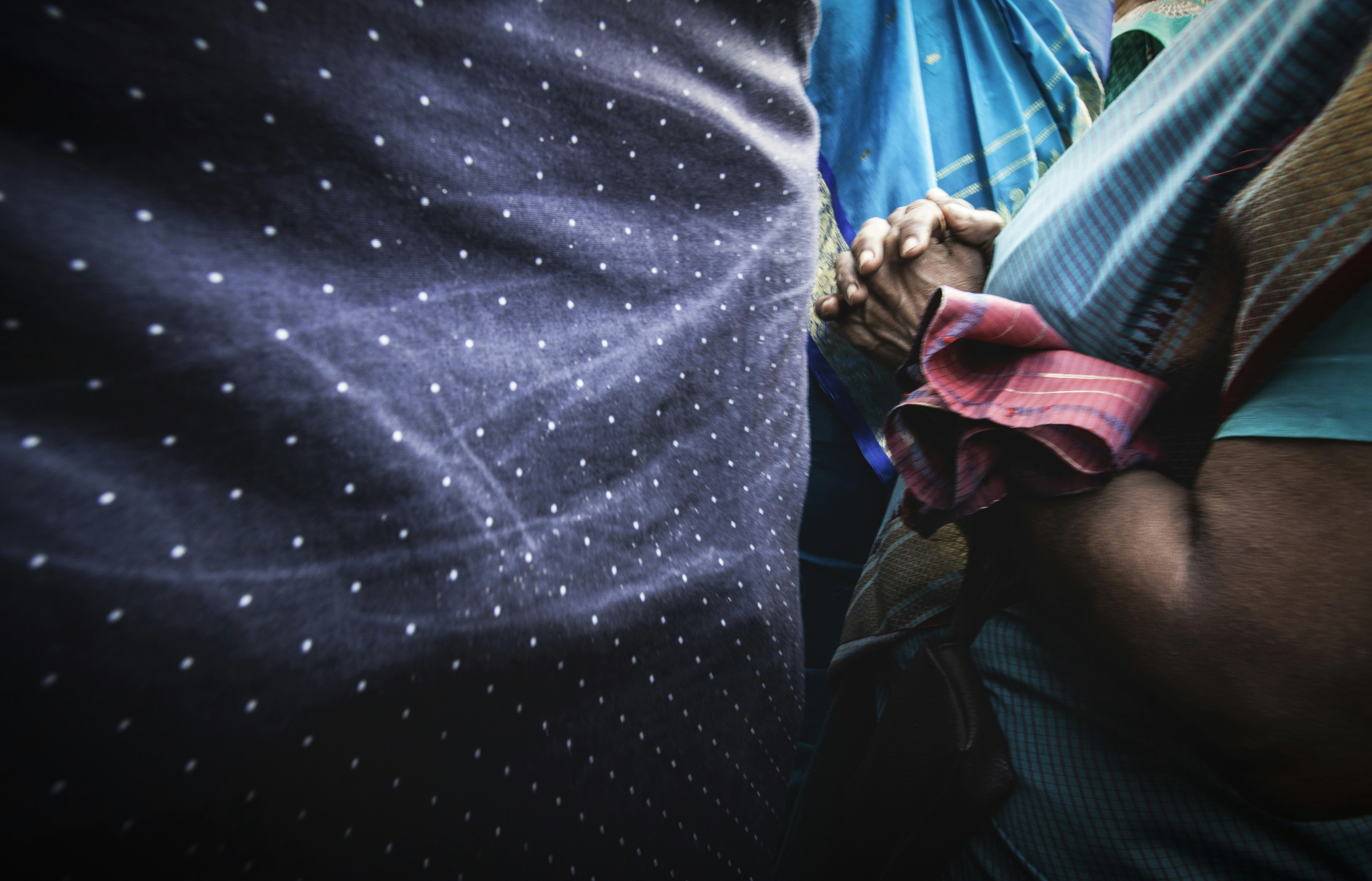 Close-up of two people holding hands