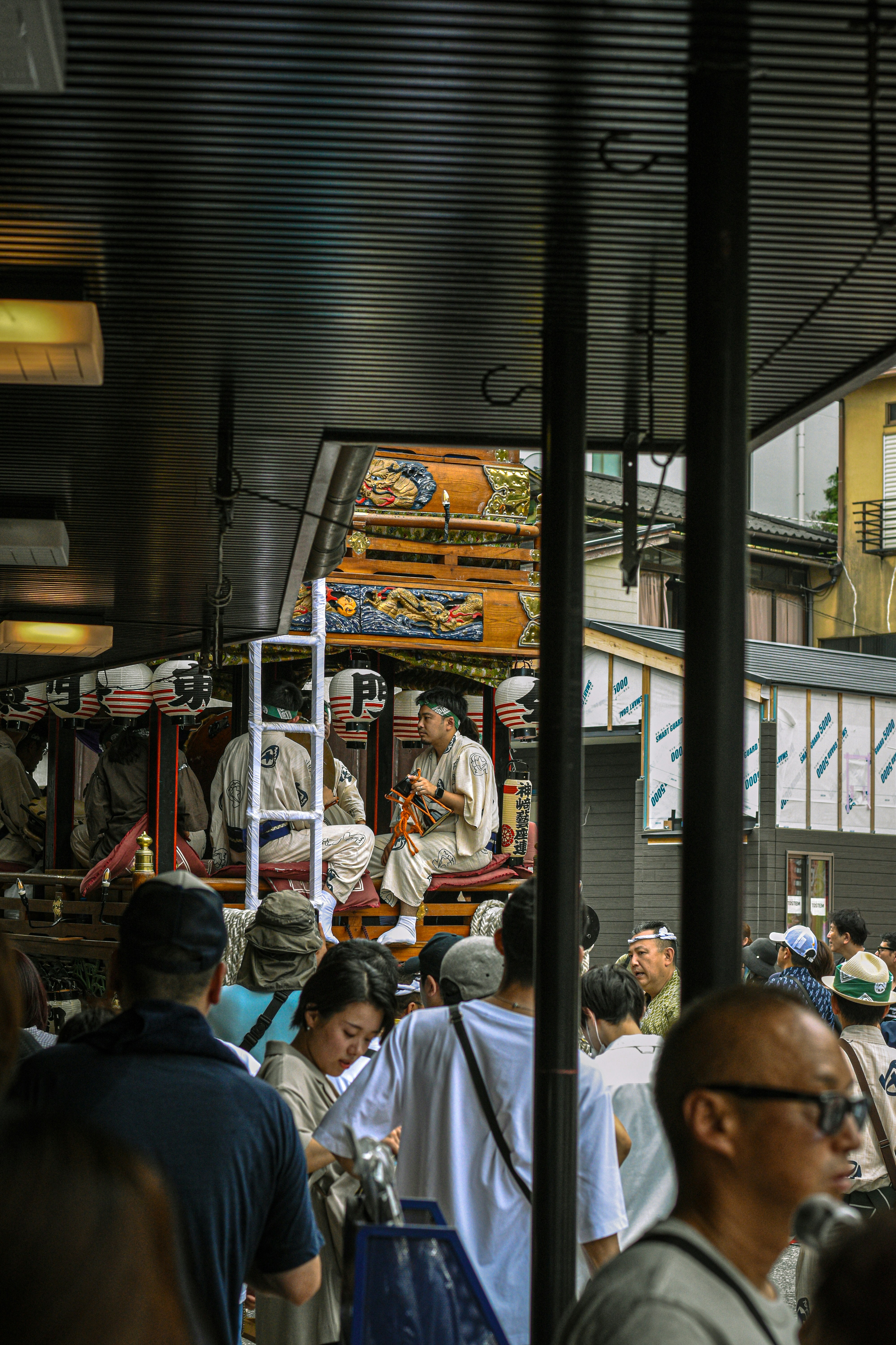 People watch a traditional japanese festival float procession.