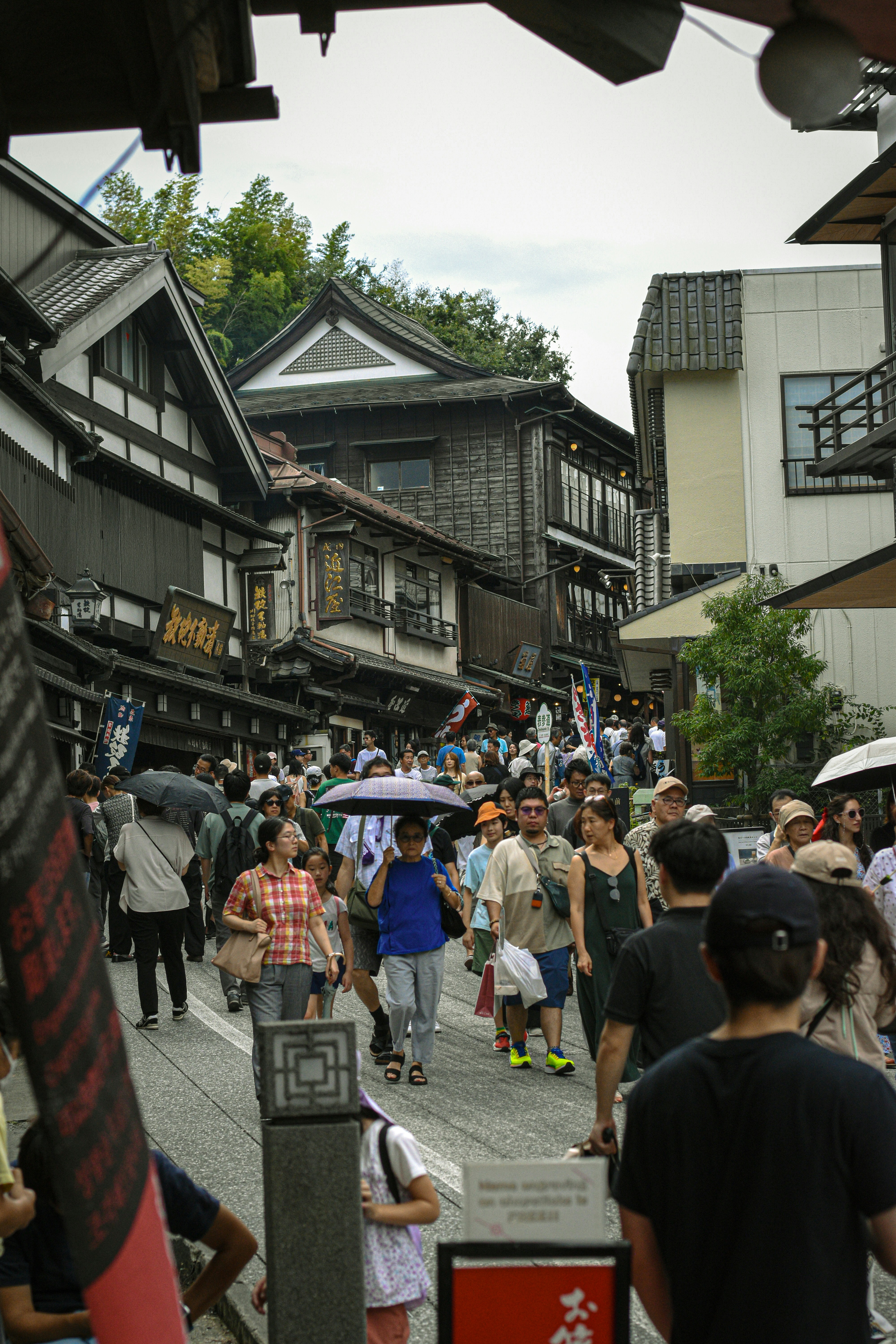 Crowded Timber-Front Street: Tourists Navigating a Historic Alley