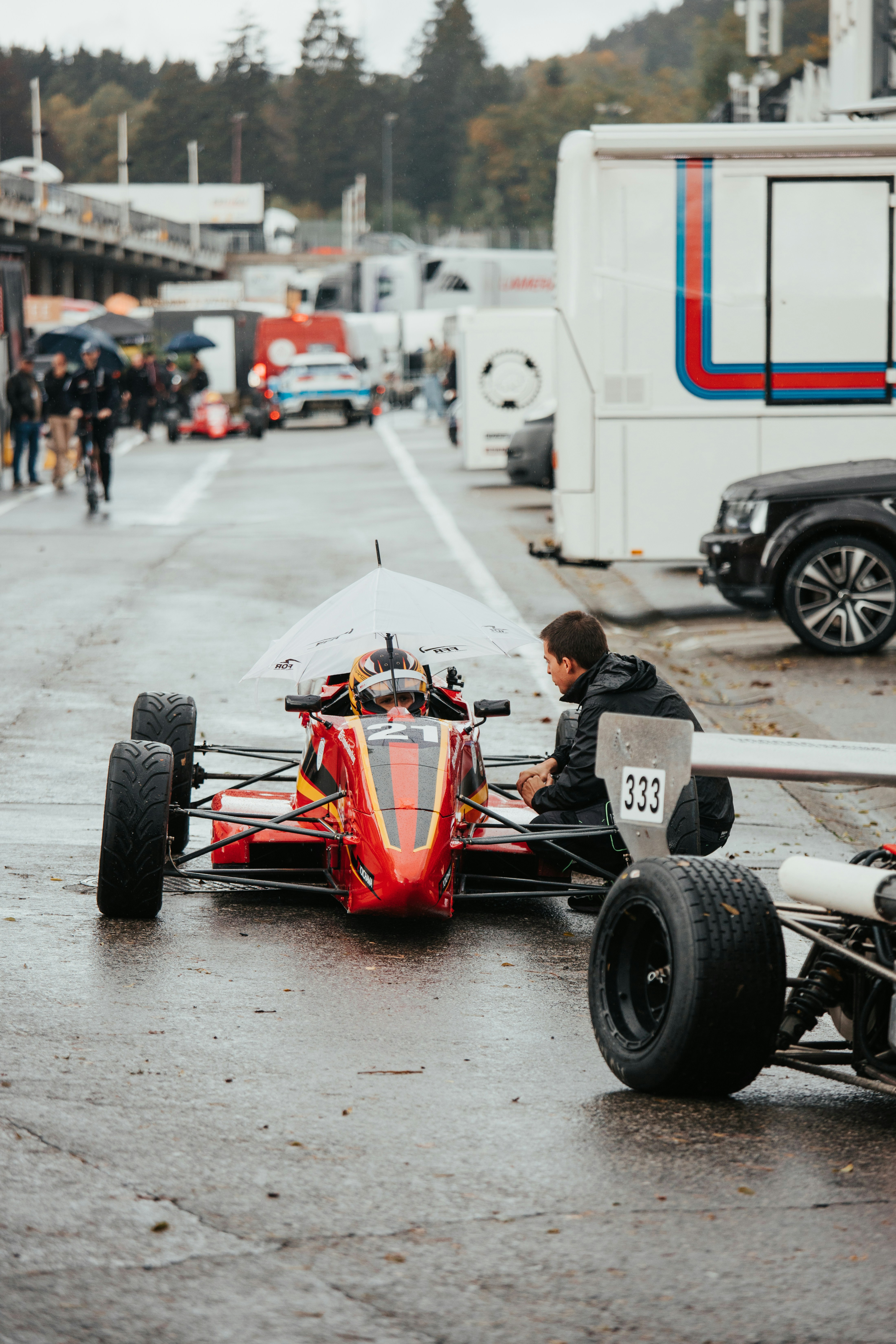 A red race car on a wet track