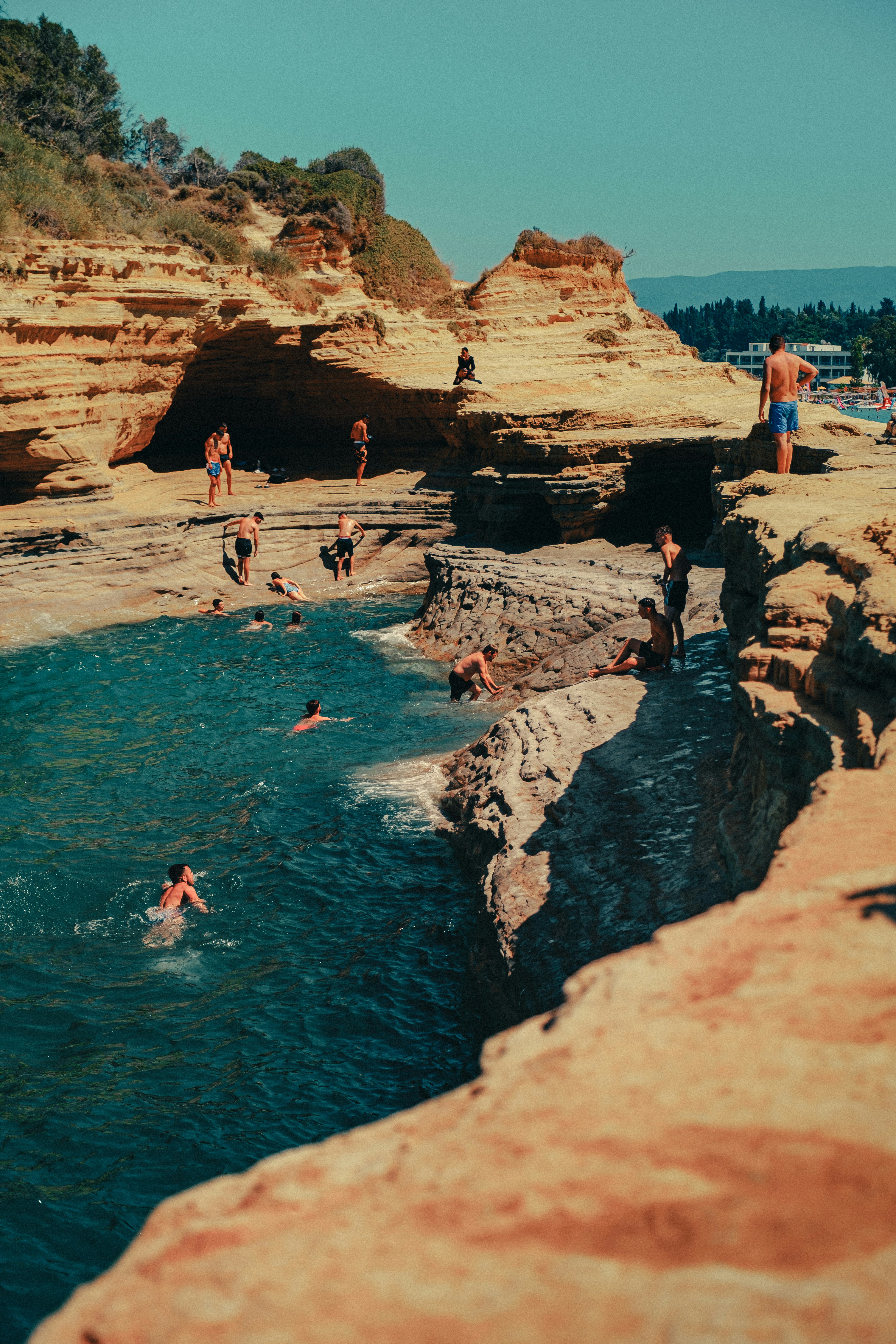 For any use contact me on Instagram (@benwksi) :) | People swimming and sunbathing on rocky coastline