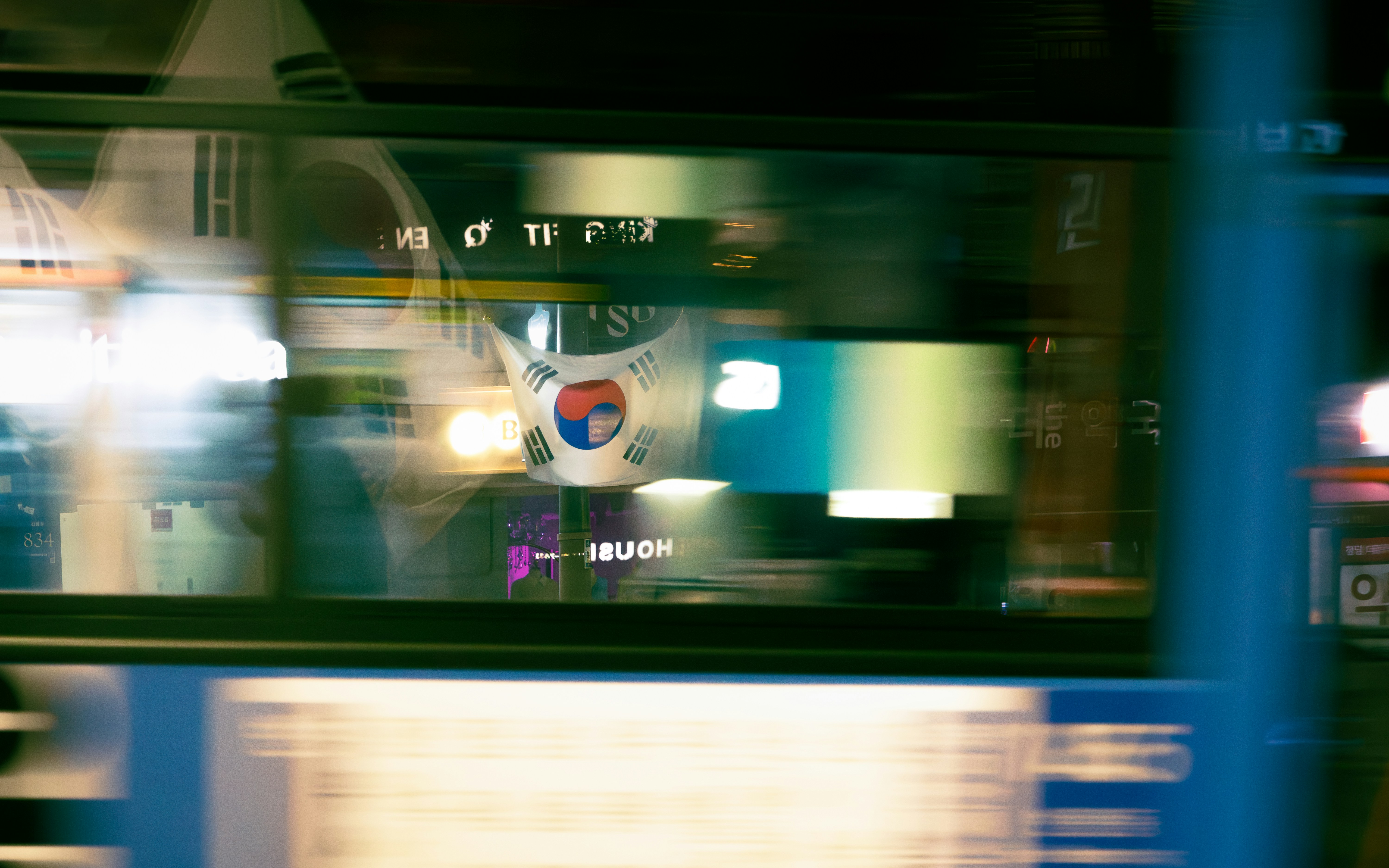 Blurry view of city lights through a window