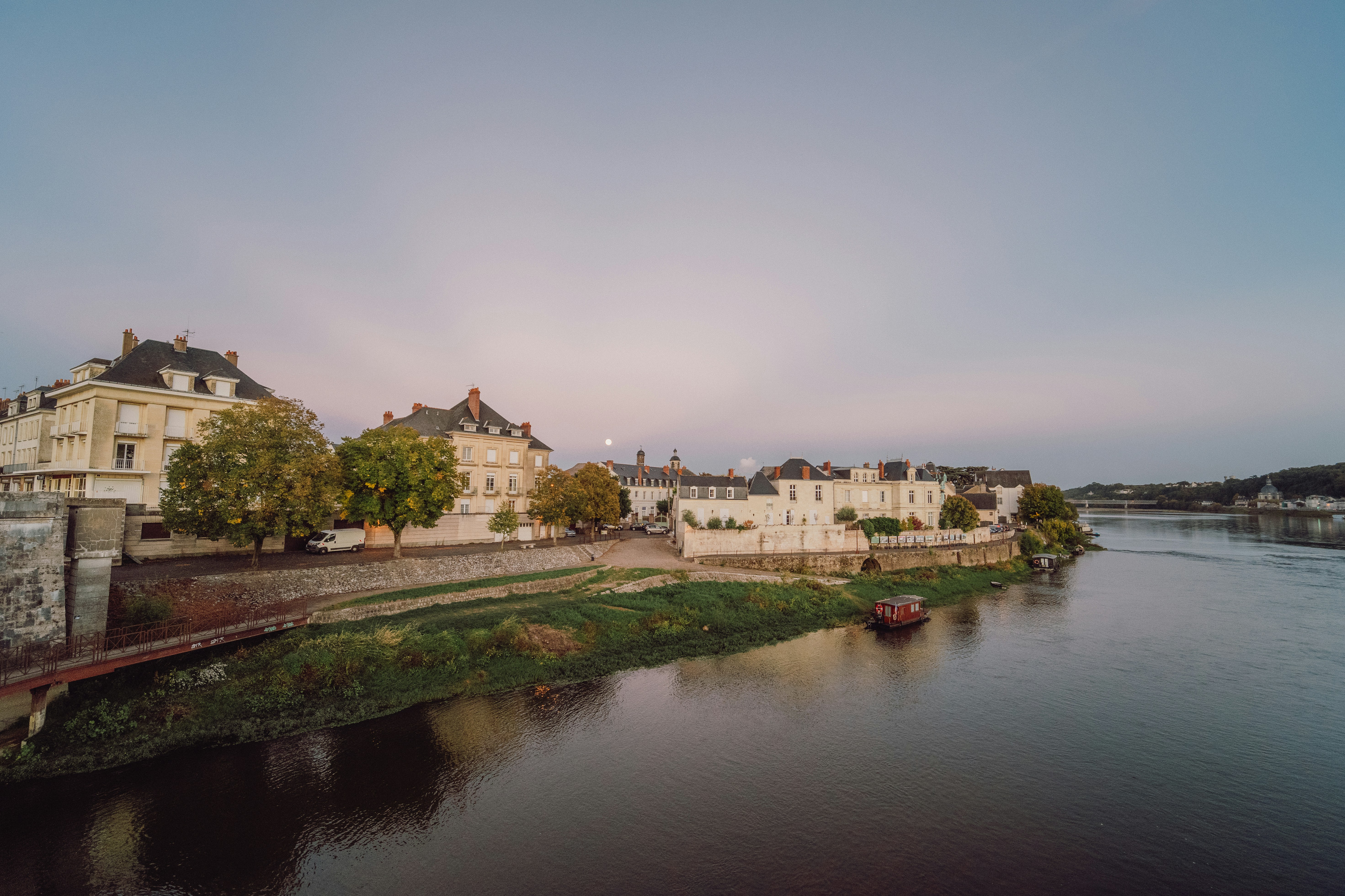 River flowing past buildings in a european town.